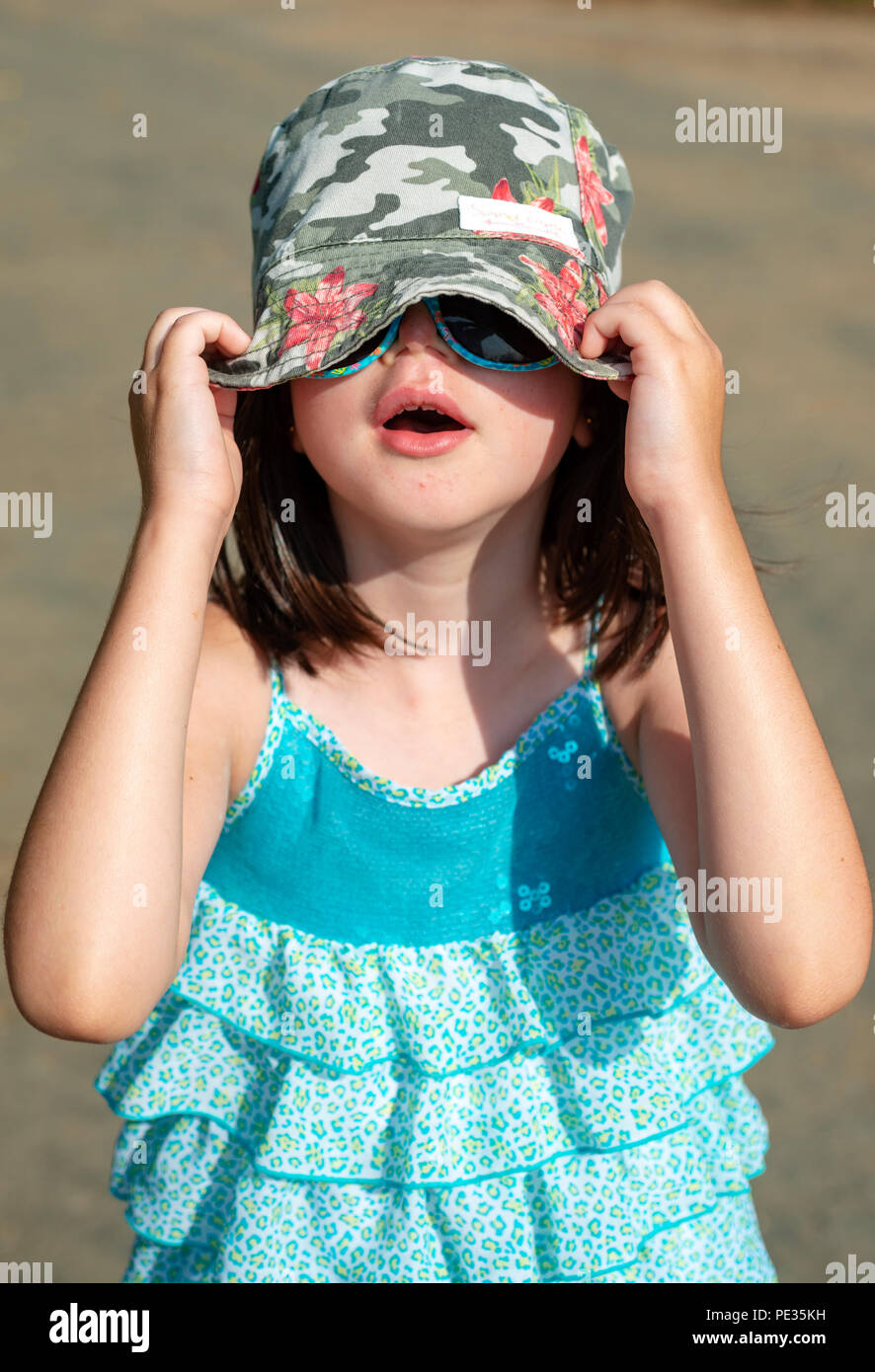 Young girl trying to keep the hot sun off her face Stock Photo - Alamy