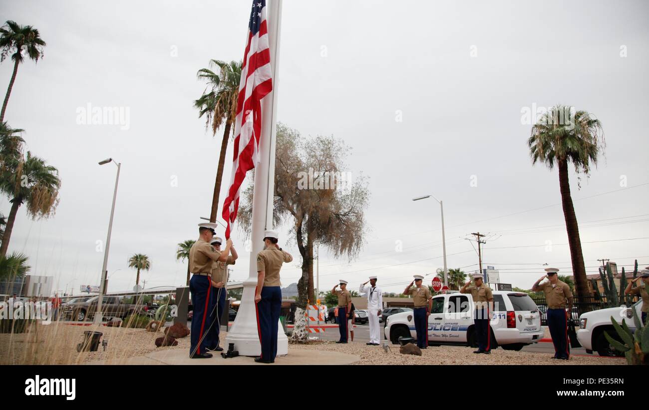 Marines and a sailor salute the American flag during the “National ...