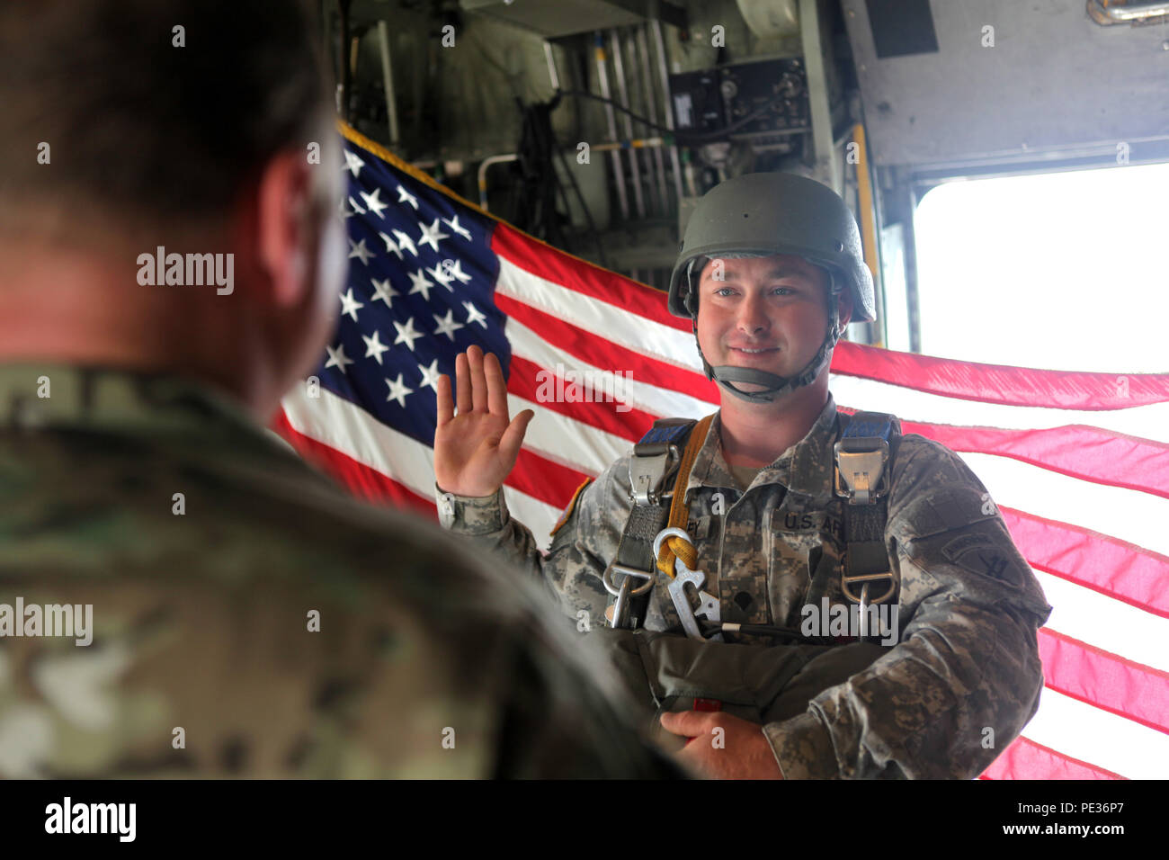 U.S. Army Spc. John McKenney repeats the oath of enlistment during his ...
