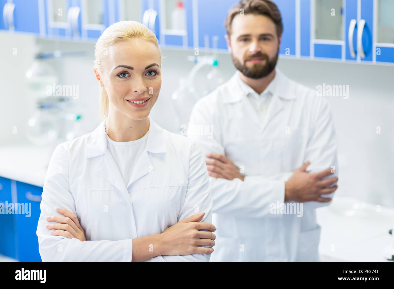 Laboratory workers. Delighted nice female researcher smiling an ...
