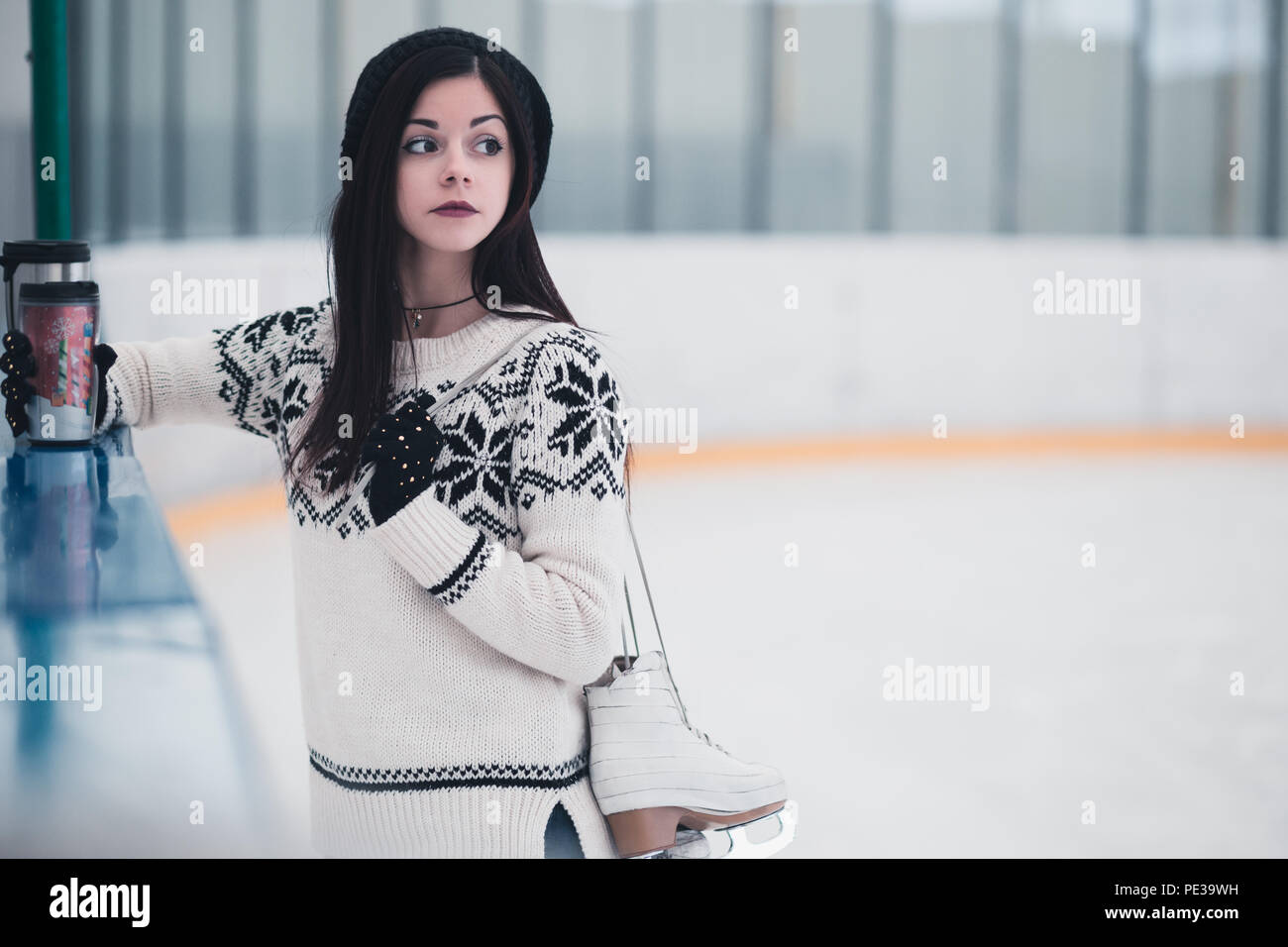 Pretty young woman at ice-skating rink Stock Photo - Alamy