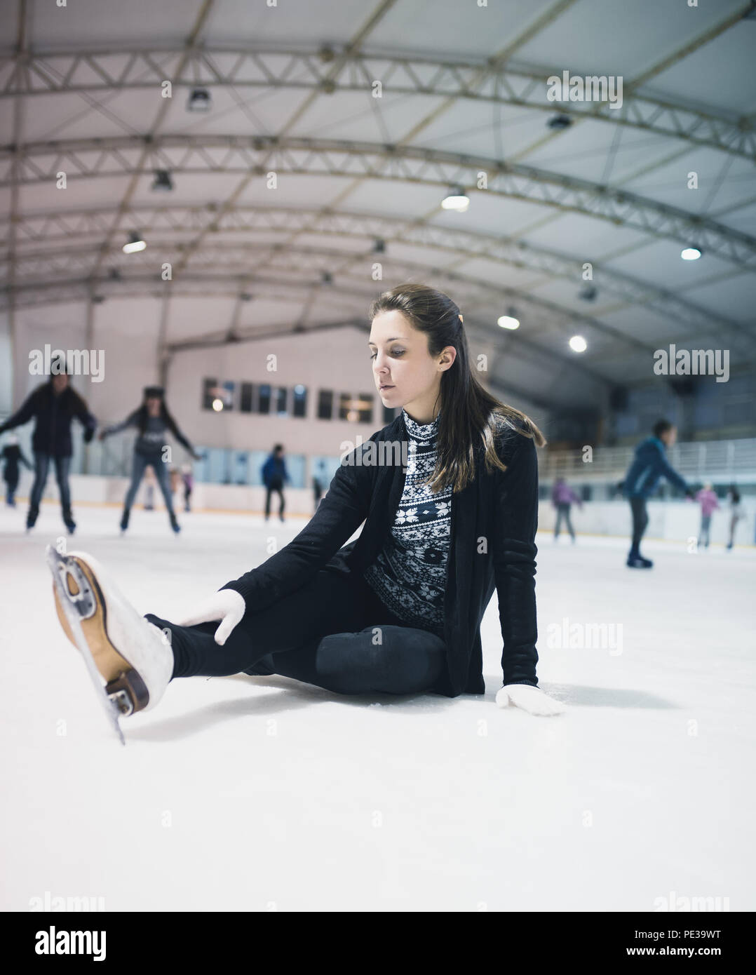Pretty young woman at ice-skating rink Stock Photo - Alamy