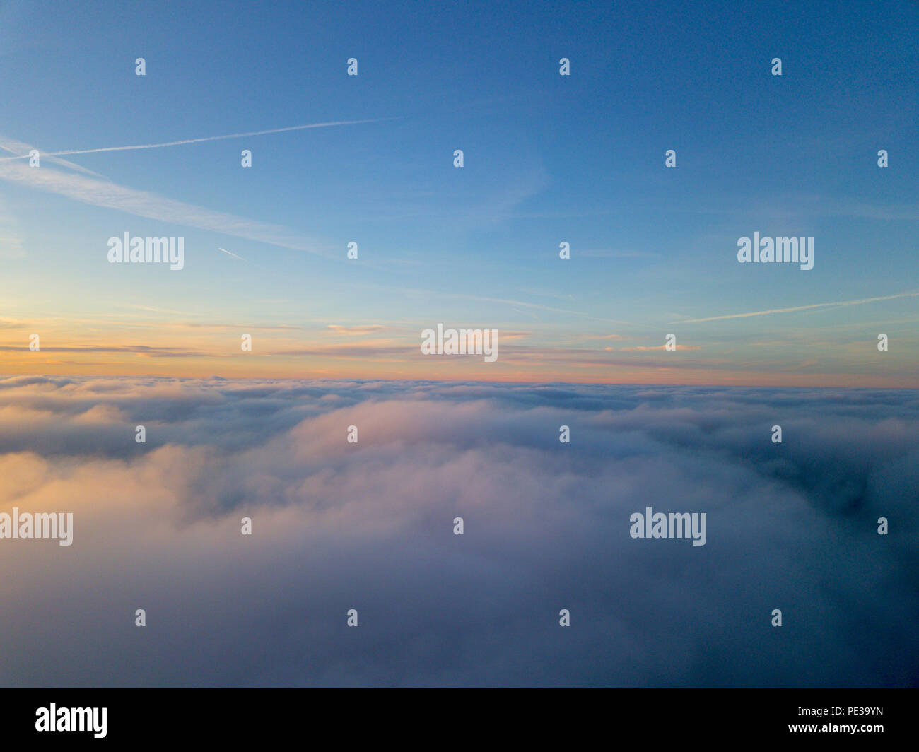 Sunset above clouds Stock Photo - Alamy