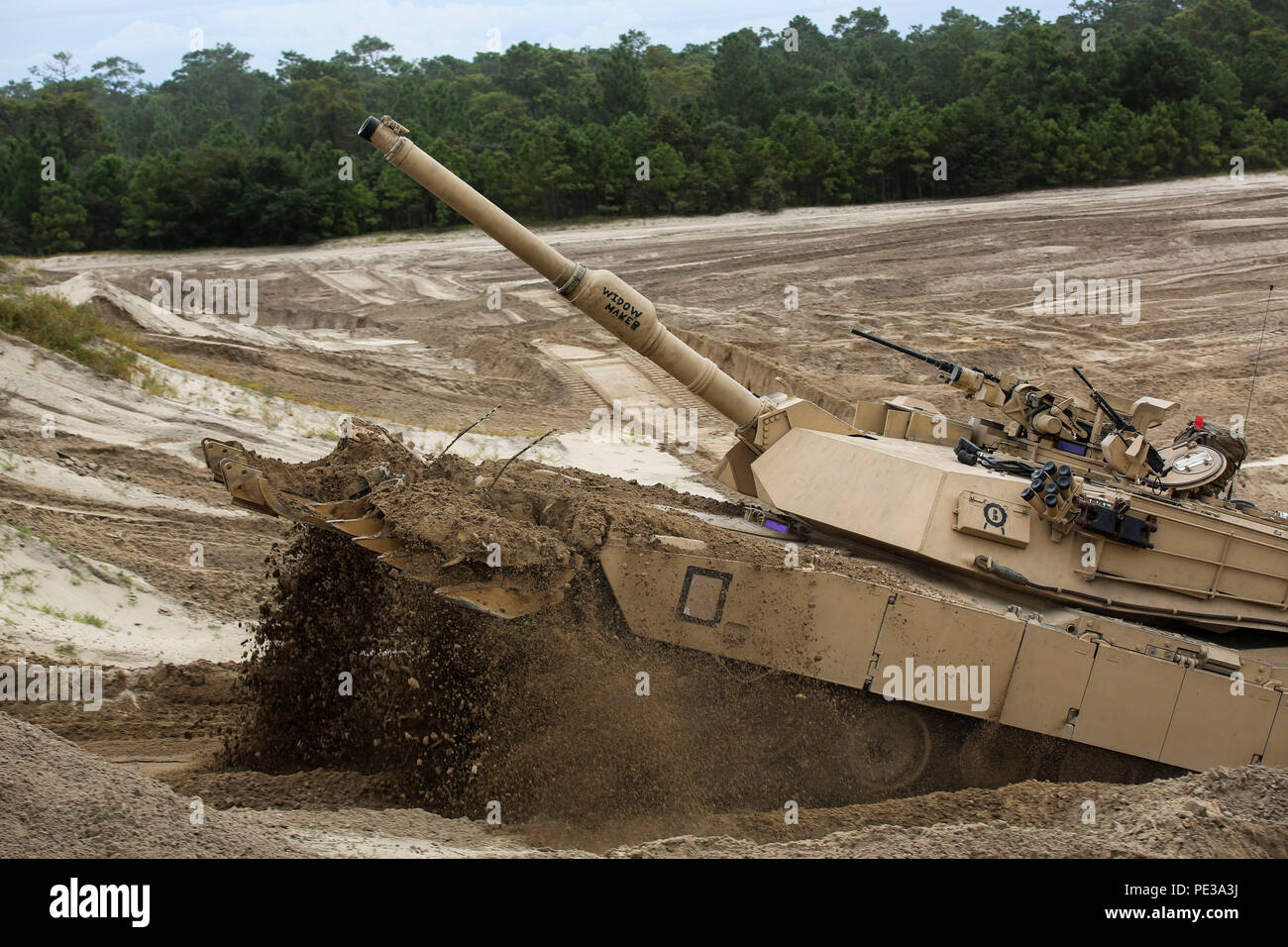 Marines with Alpha Company, 2nd Tank Battalion, drive an M1 Abrams tank ...