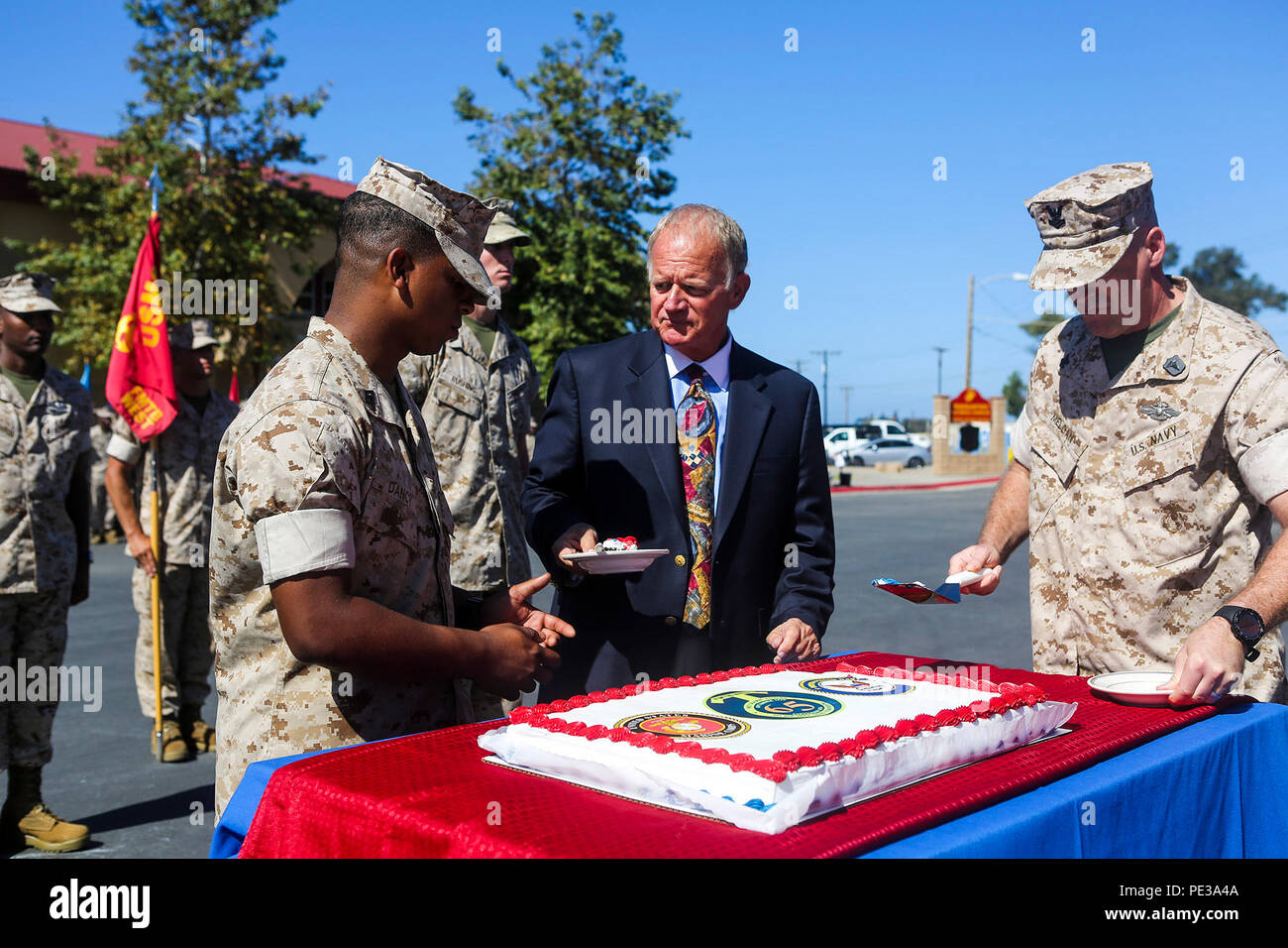 A former U.S. Navy Corpsman presents the first piece of cake to the ...