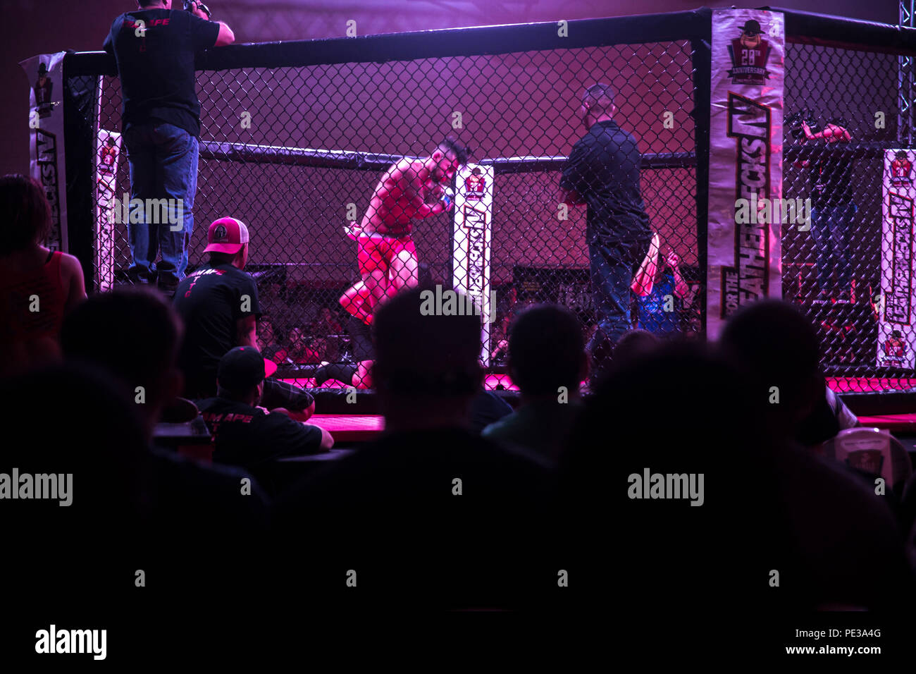 A crowd of Marines and sailors watch a fight during the Leathernecks IV ...