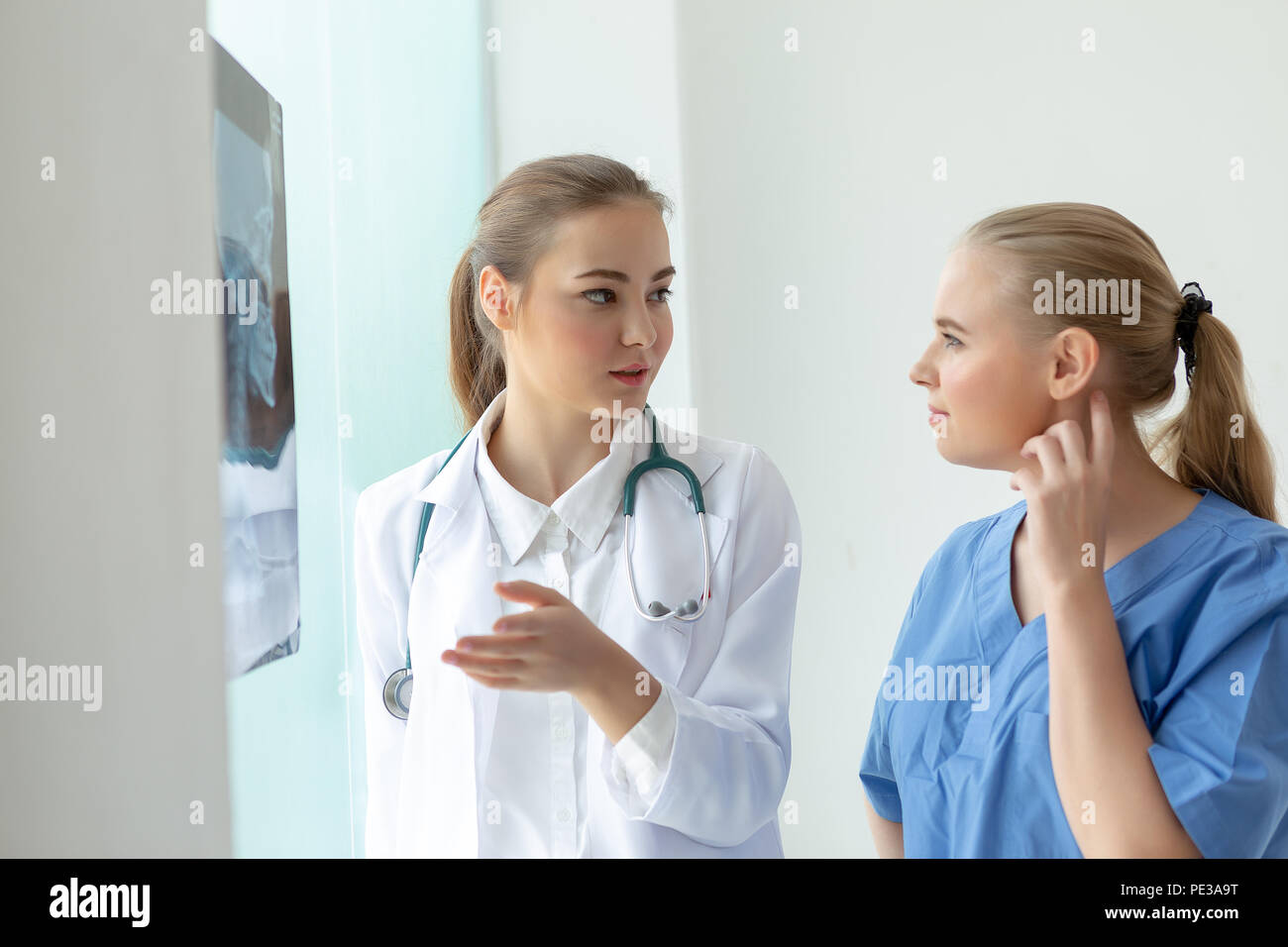 Doctors women discussion and reviewing a resonance magnetic imaging or ...