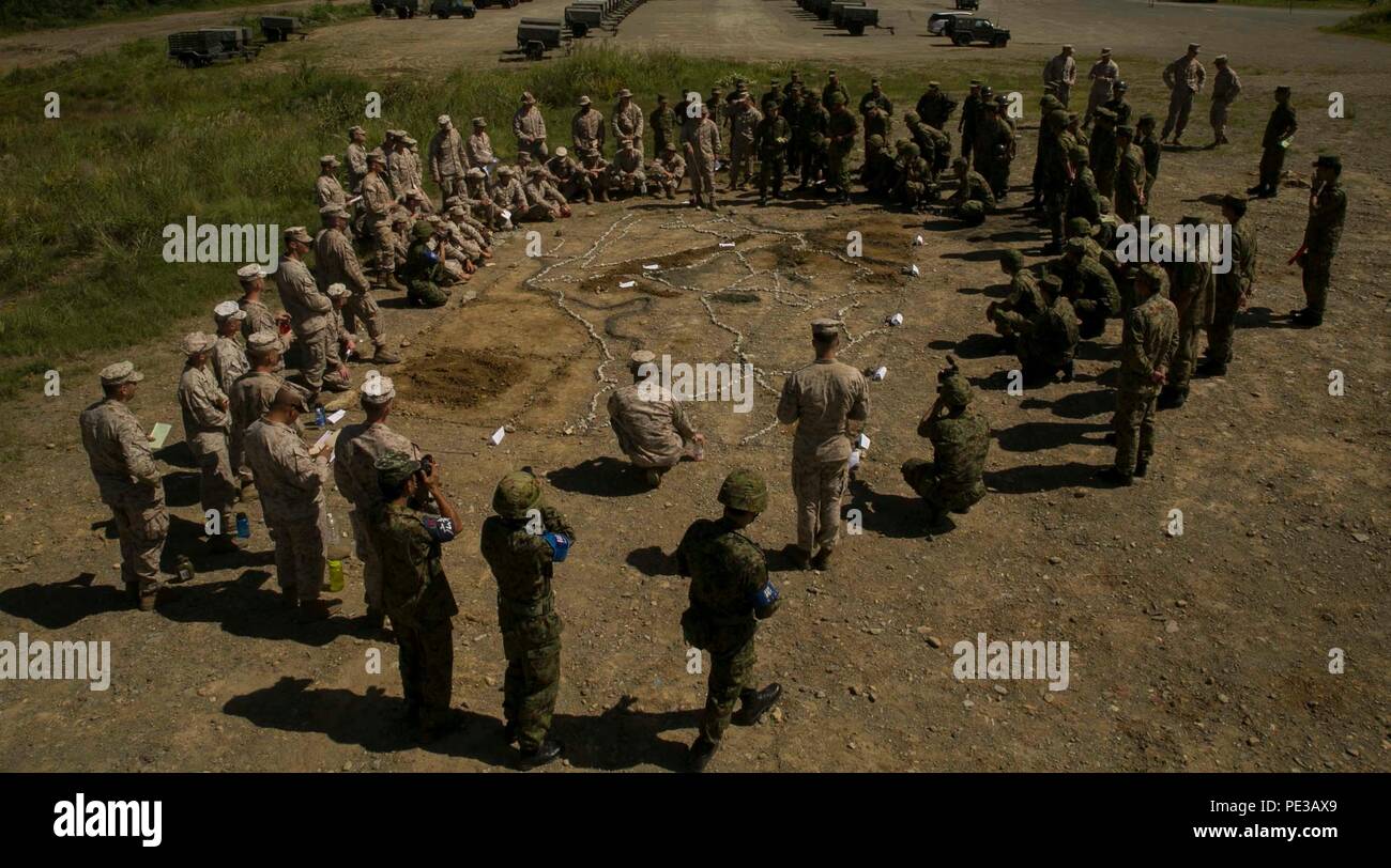 Japan Ground Self-Defense Force members and Marines gather around a ...