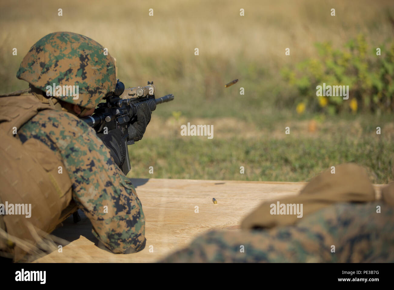 A U.S. Marine with Combined Arms Company battle sight zero their weapon ...