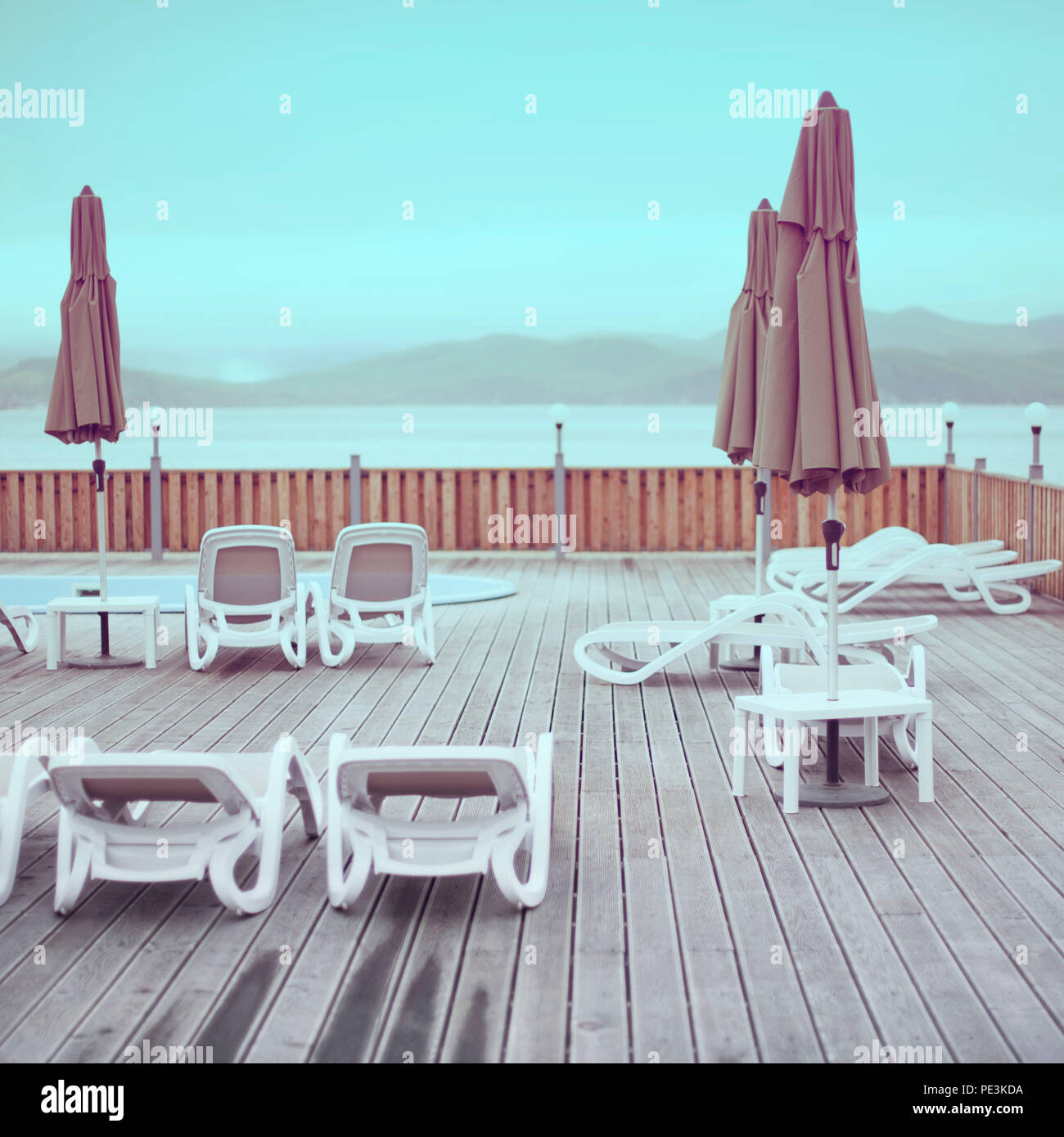 Wooden deck beach sea ocean resort sun lounger umbrella hotel pool sky ...