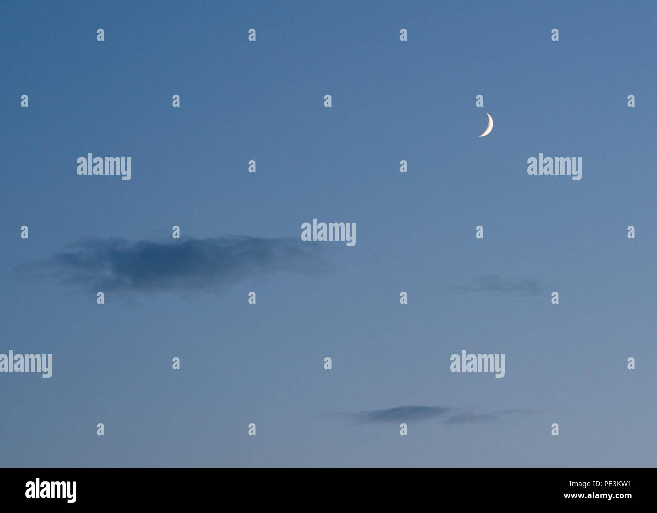 Twilight clear blue sky with perfect crescent moon and clouds for ...