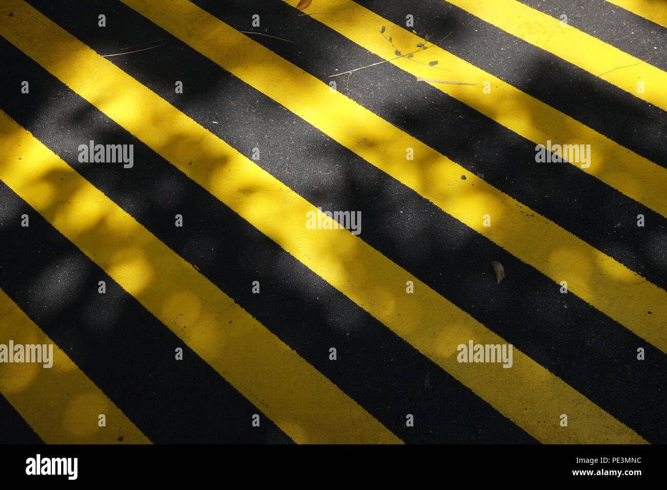 Industrial striped road warning yellow-black pattern Stock Photo - Alamy
