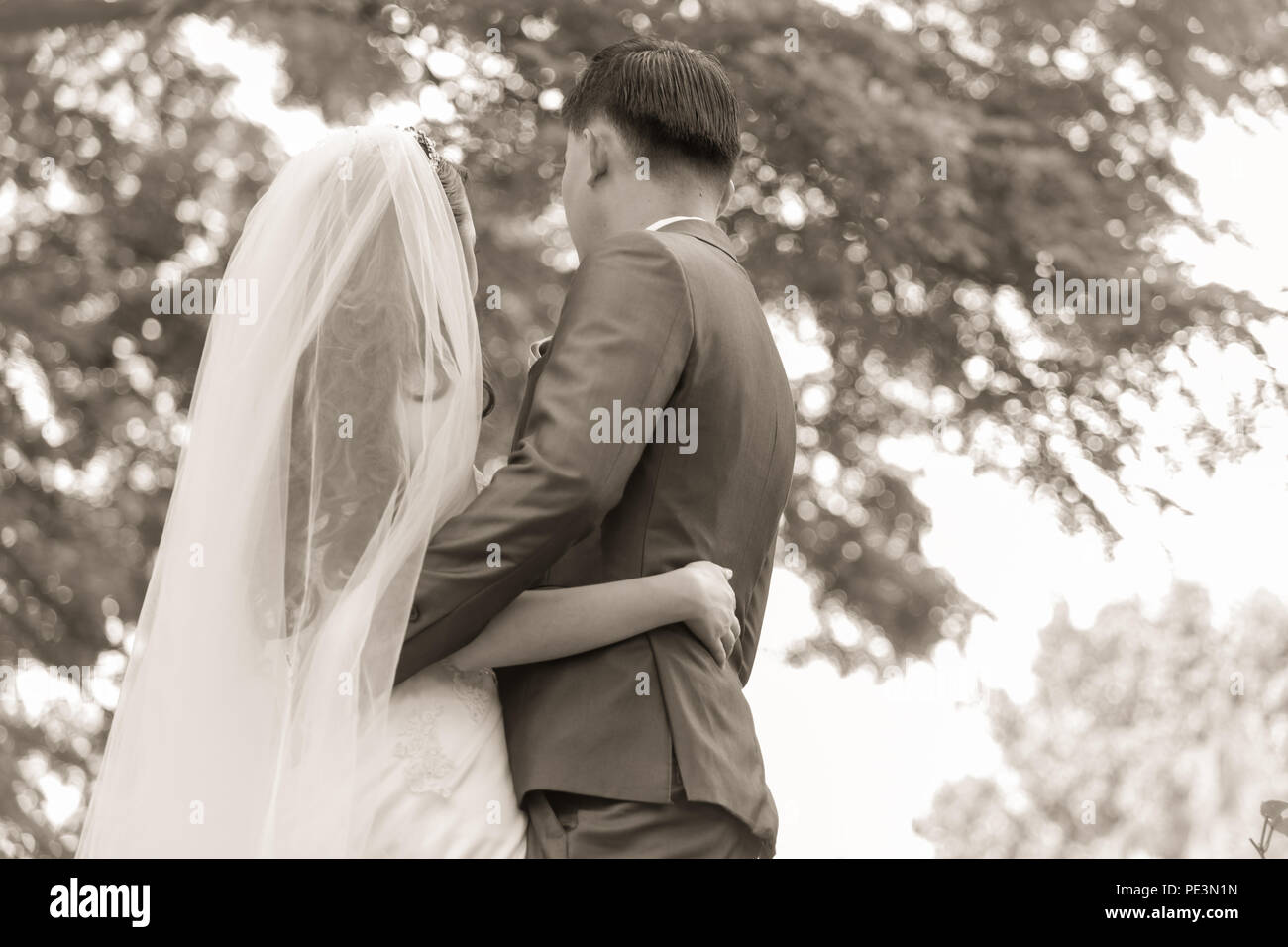 Married bride and groom embracing each other as a symbol of love and ...