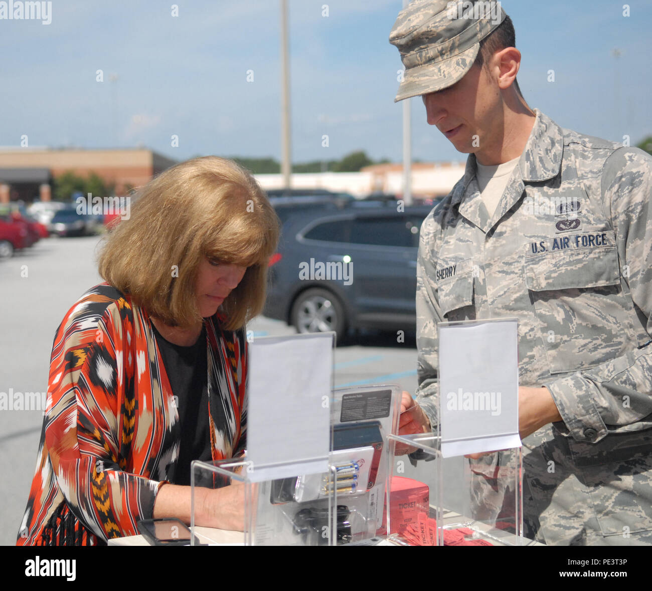 Senior Airman Joseph Sherry, emergency management journeyman, assists ...