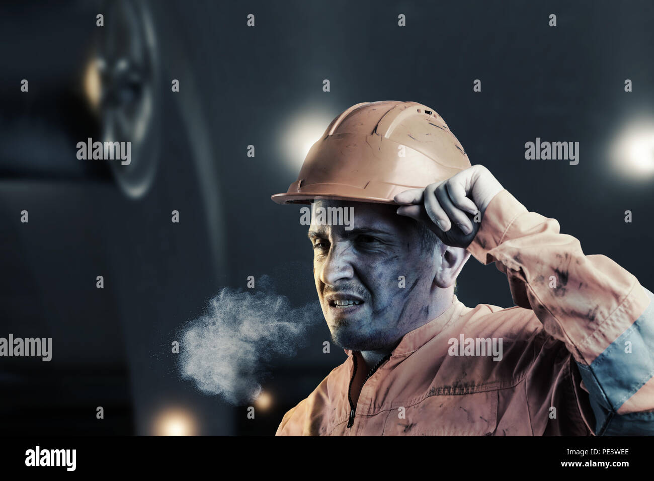 portrait of tired rail worker with orange unifom and helmet light in ...