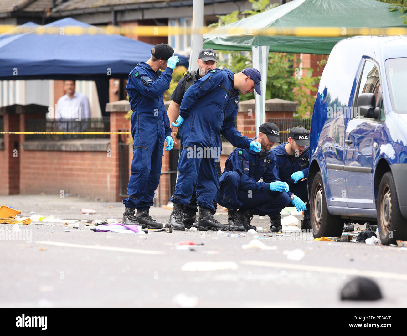 Police from the Tactical Aid Unit carry out a fingertip search in ...