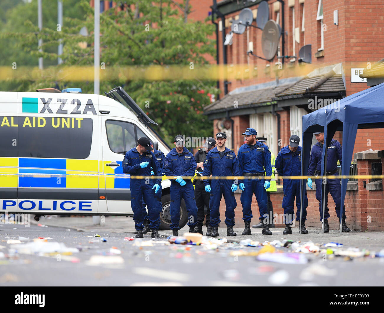Police from the Tactical Aid Unit carry out a fingertip search in ...