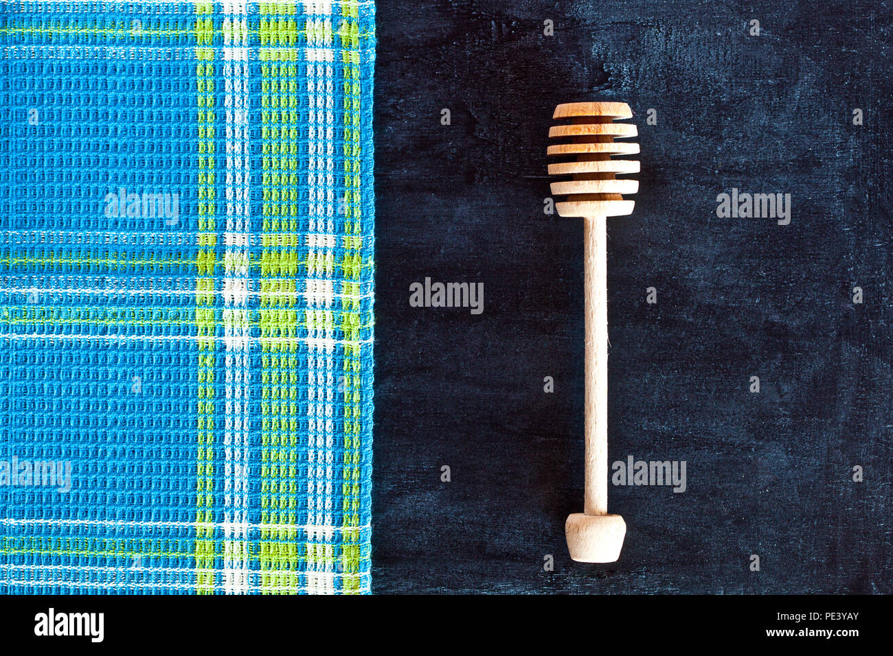 honey stick and tablecloth over blackboard background Stock Photo - Alamy