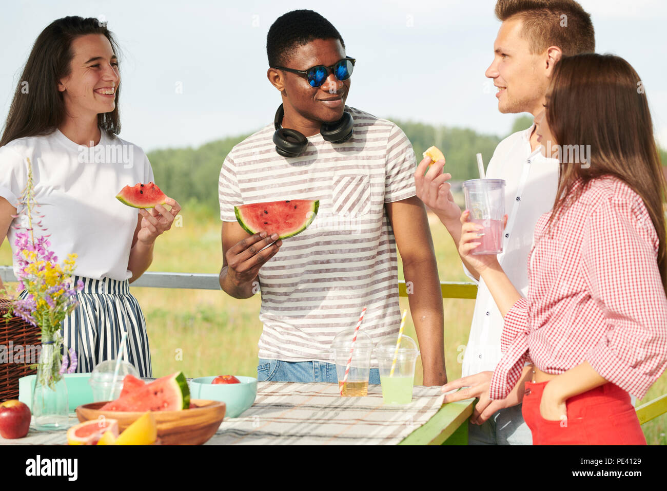 People eating watermelon Stock Photo - Alamy