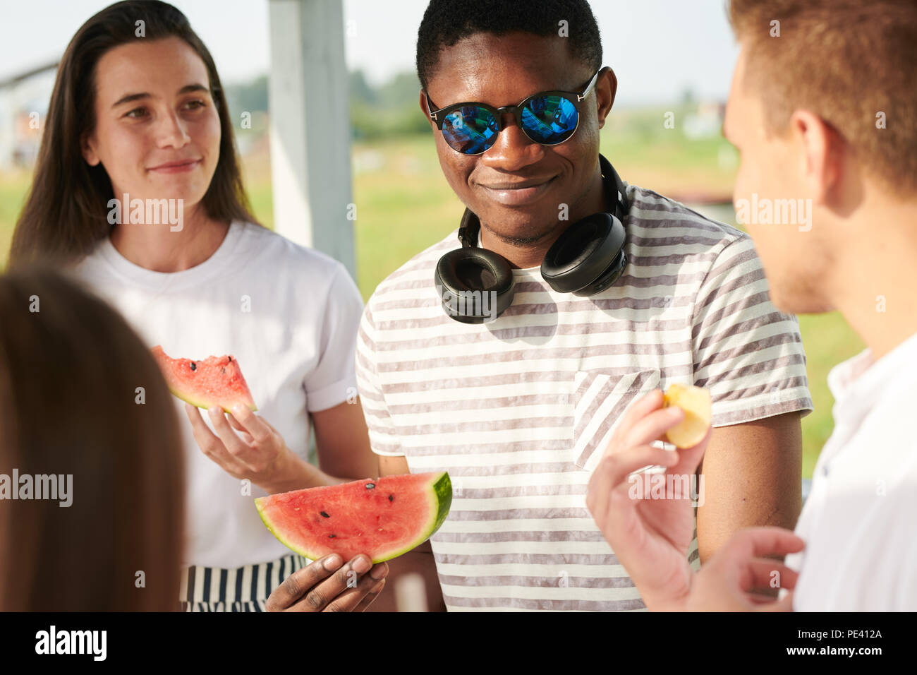 People eating fruits outdoors Stock Photo - Alamy