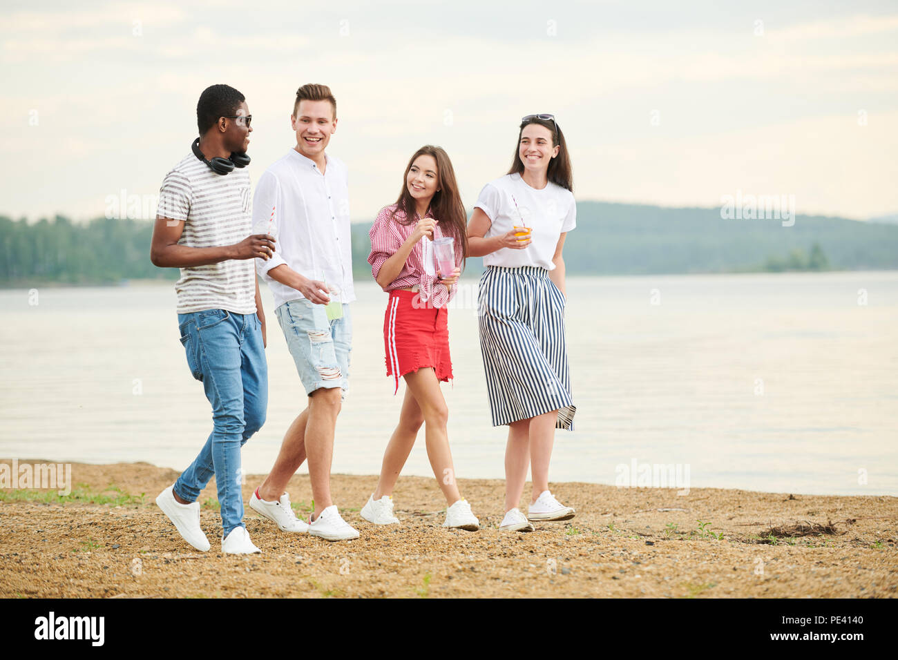 People walking on the beach Stock Photo - Alamy