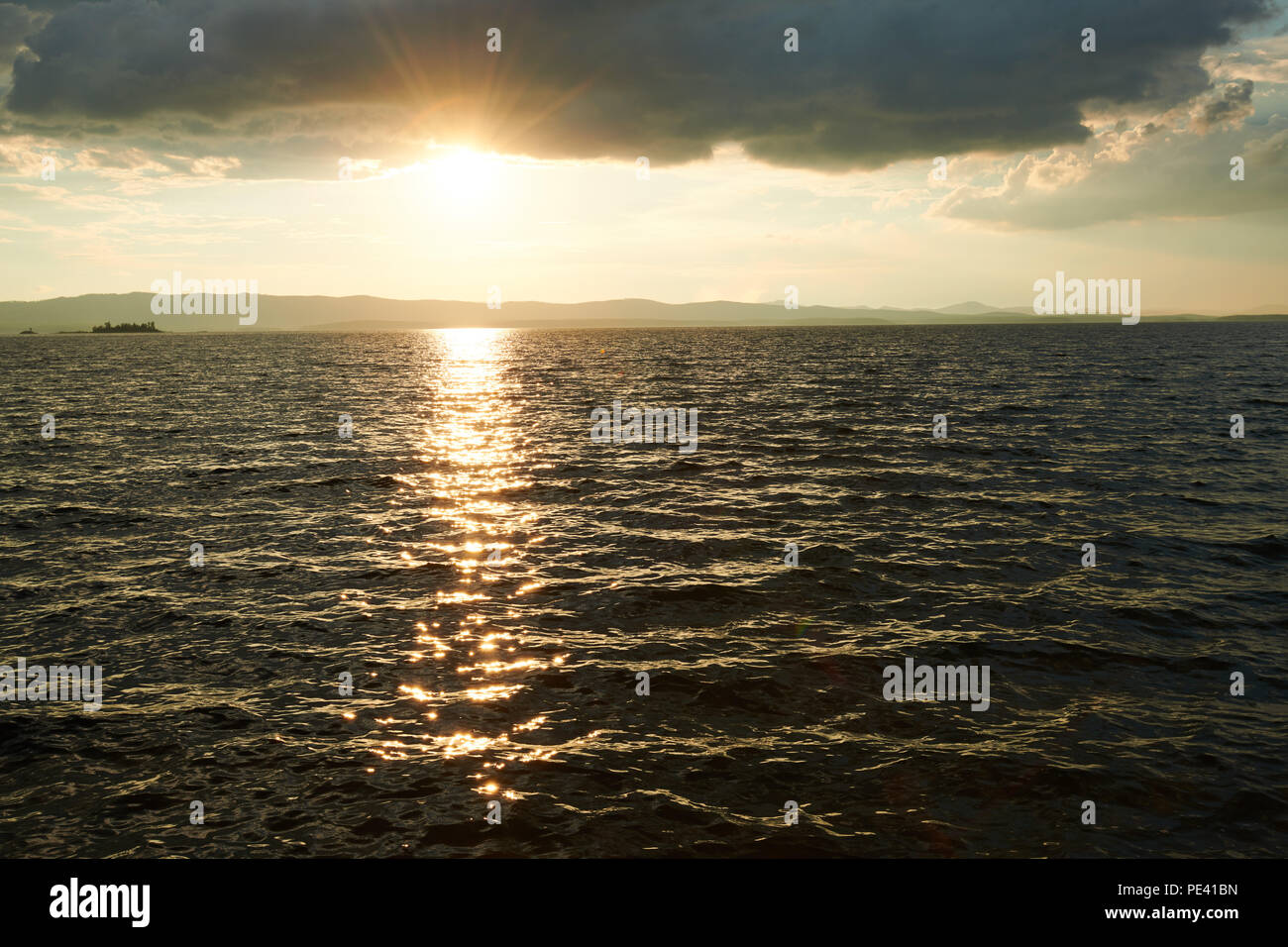 Sunset over the lake Stock Photo - Alamy