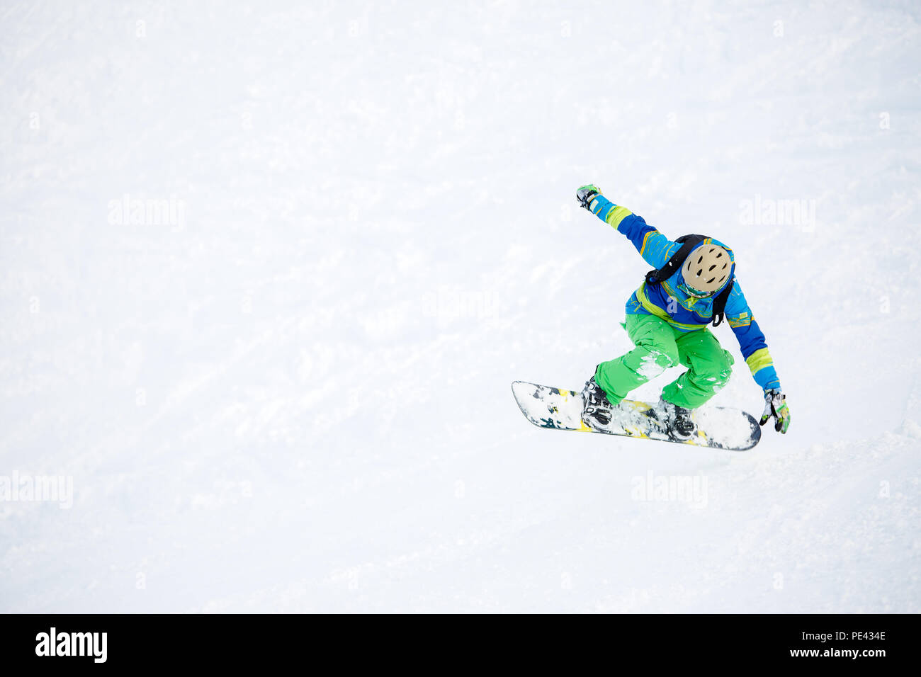 Photo of athlete riding snowboard Stock Photo - Alamy