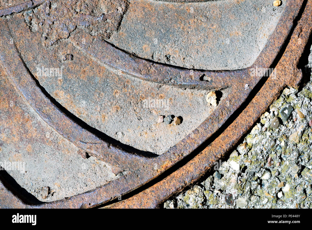 Single image of a closeup metal manhole cover with rust detail in ...