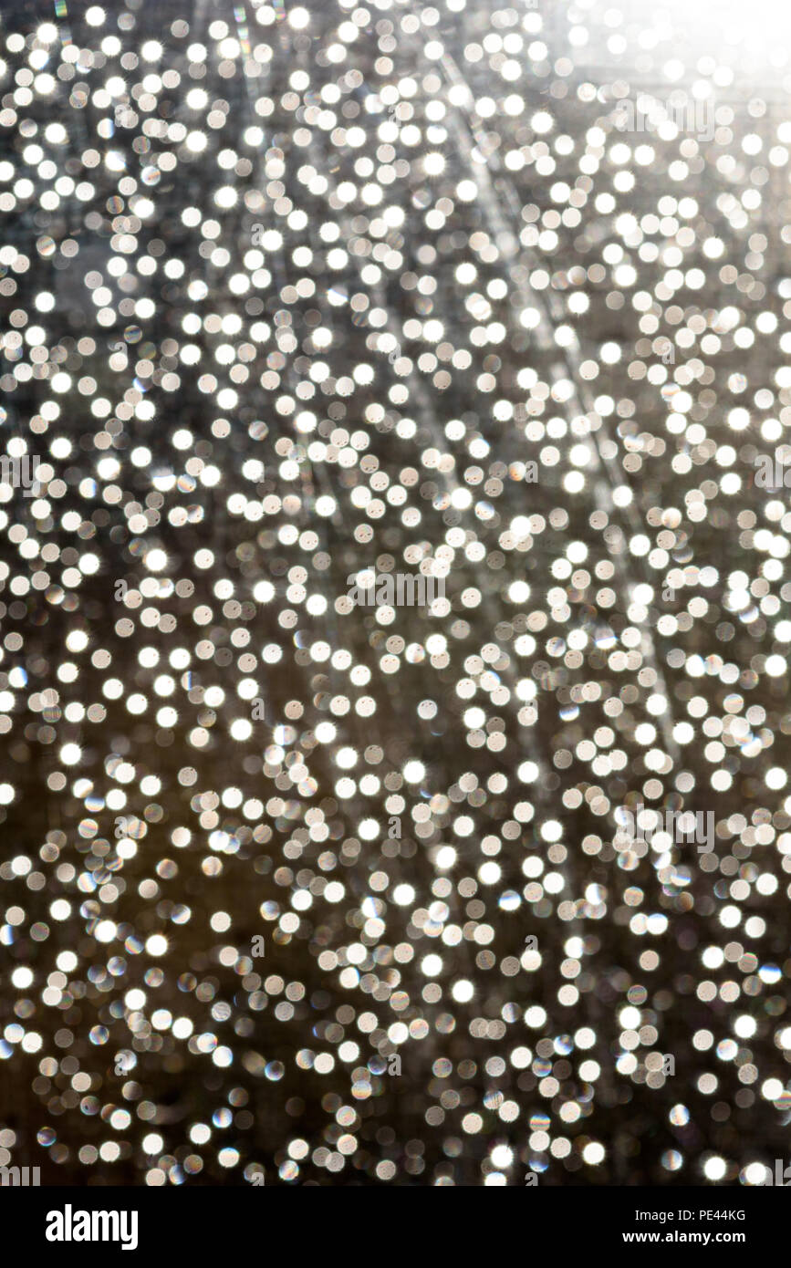 White flecks of defocused light creates a snowfall like bokeh effect in ...