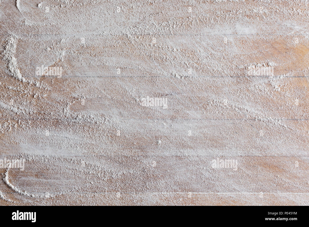 Rough wooden rectangular used cutting board background with flour ...
