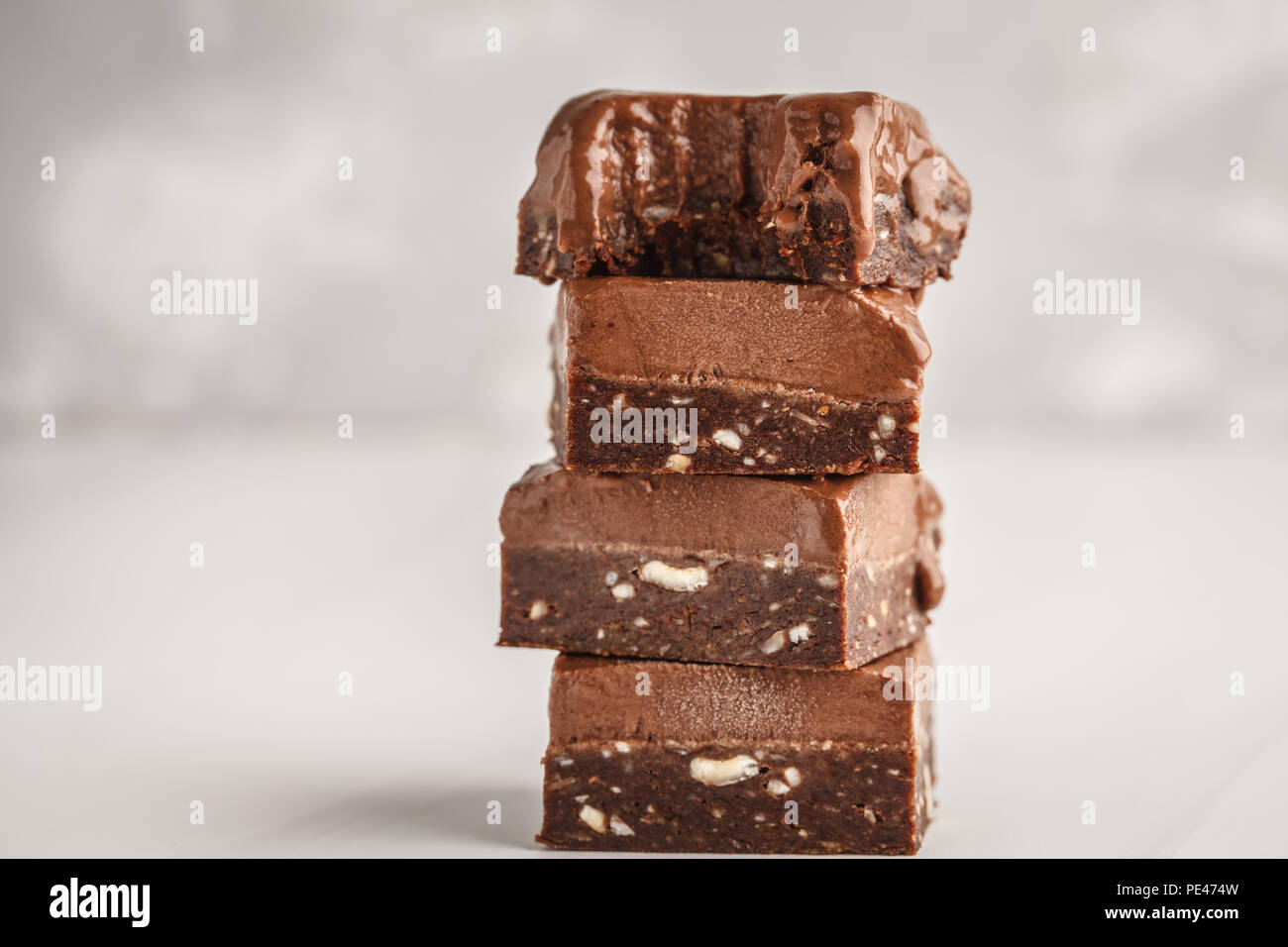 Stack of chocolate fudge bars on white background. Clean eating concept ...