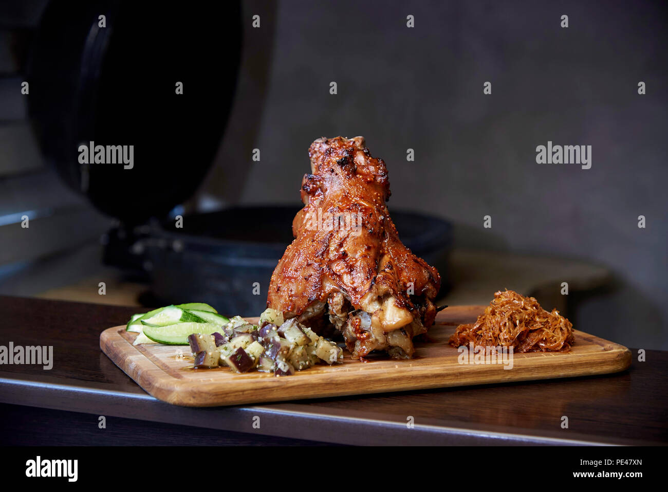 Cooked pork leg with vegetables on the grill background Stock Photo - Alamy