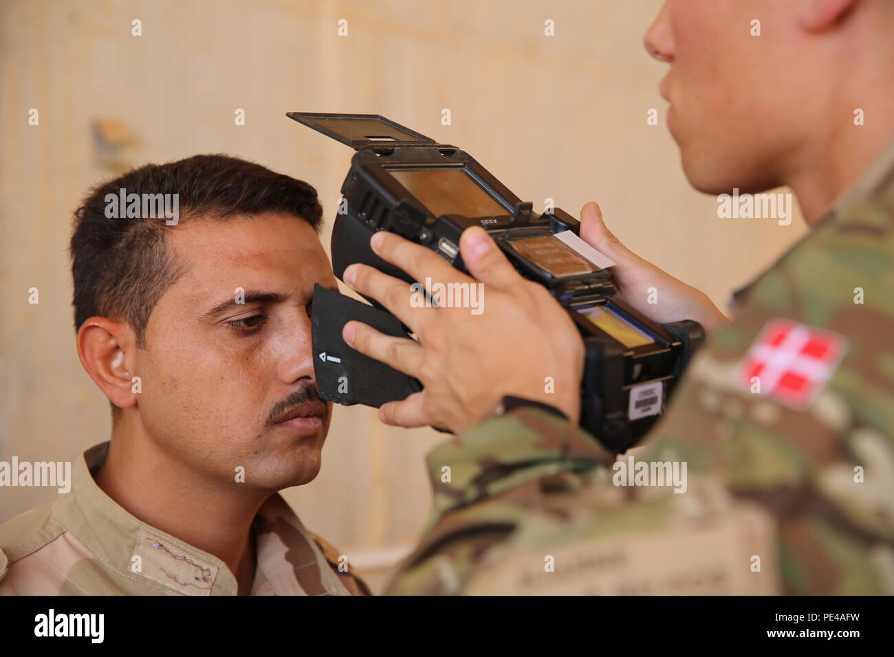 A Royal Danish army soldier, assigned to Task Force Al Asad, scans the ...