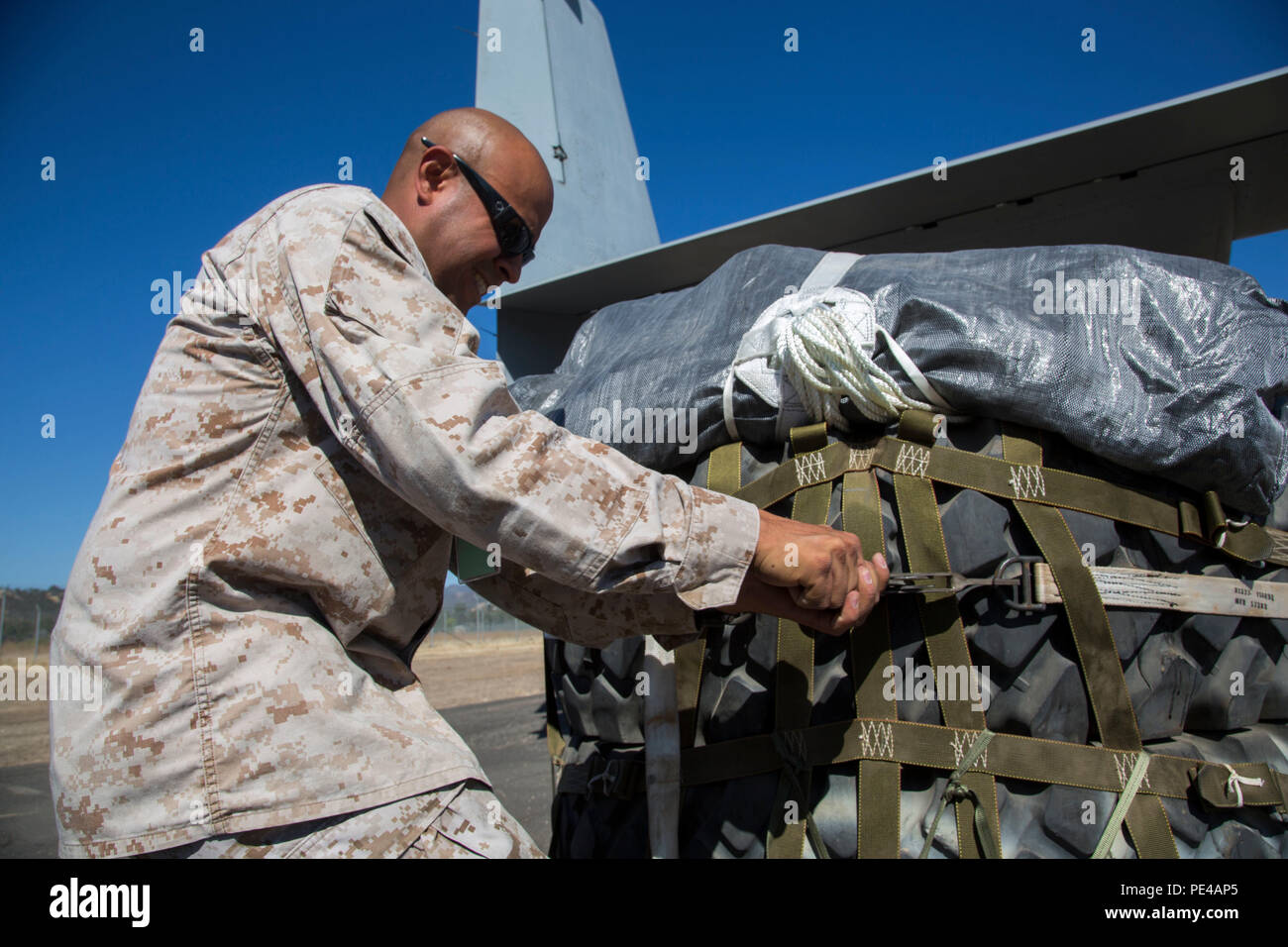 U.S. Marine Staff Sgt. Mario Rodriguez prepares a package to be air ...