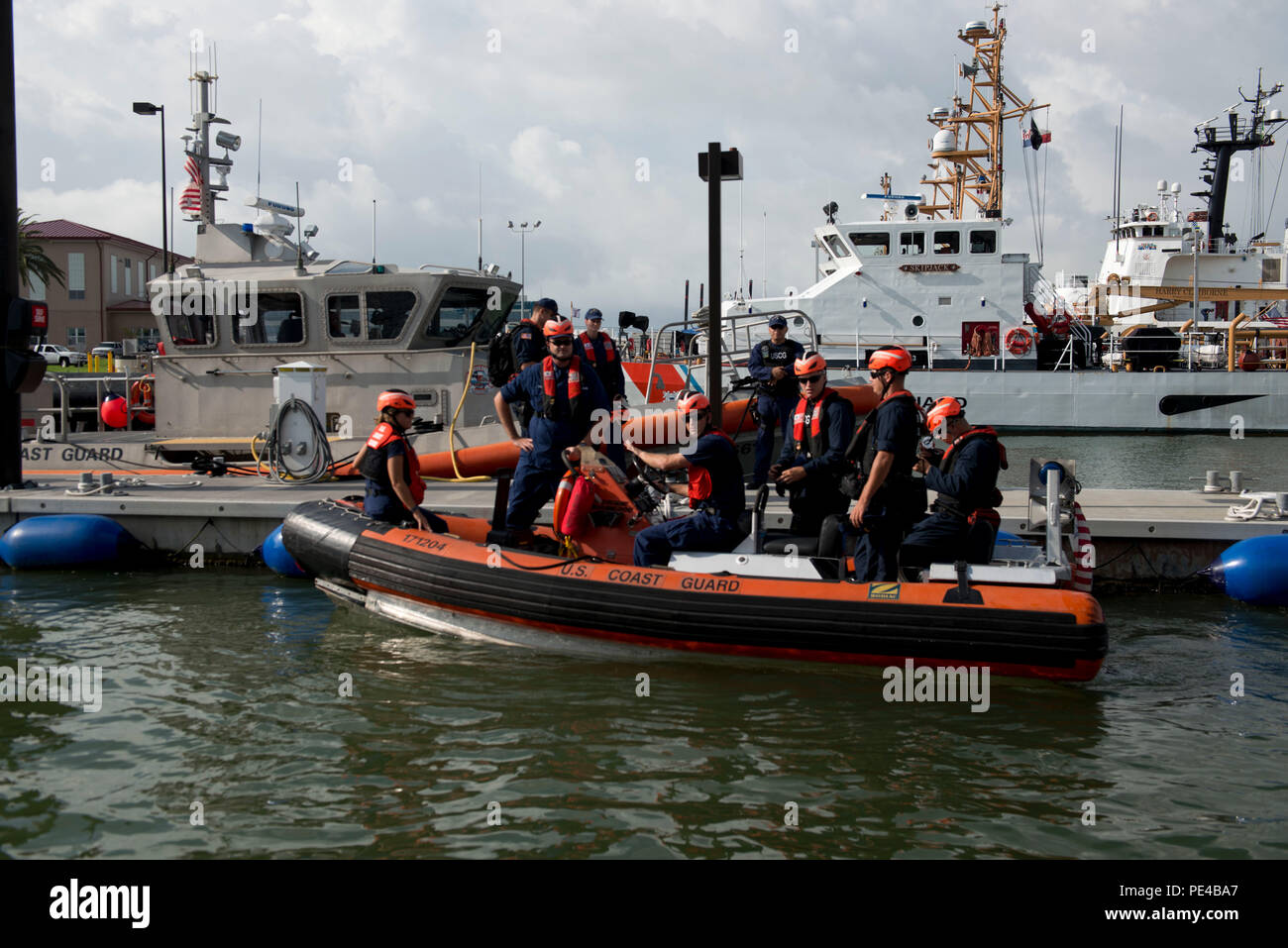 The Coast Guard Cutter Manta's small boat crew arrives at the pier to ...