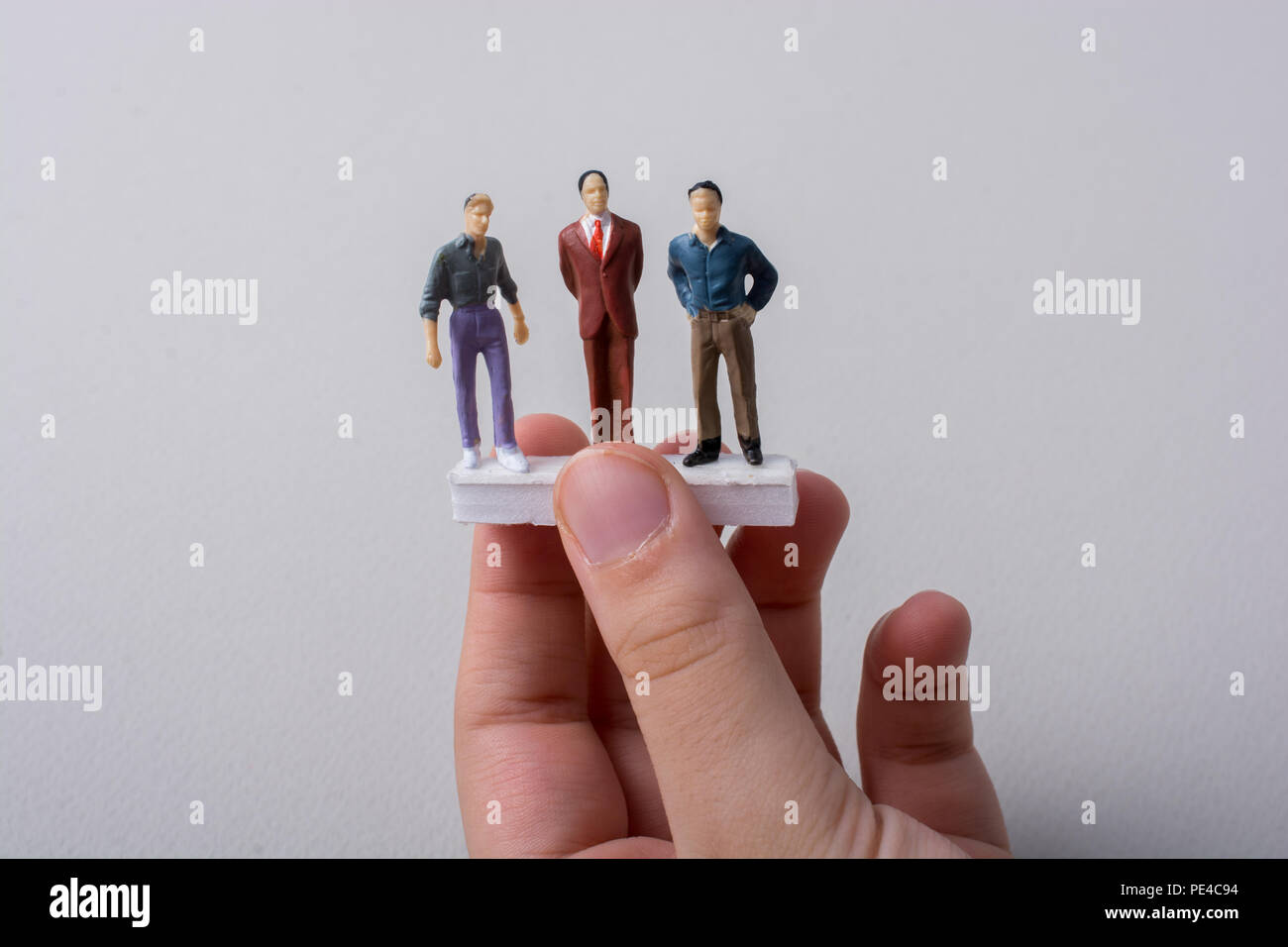Tiny figurines of men miniature model in hand Stock Photo - Alamy