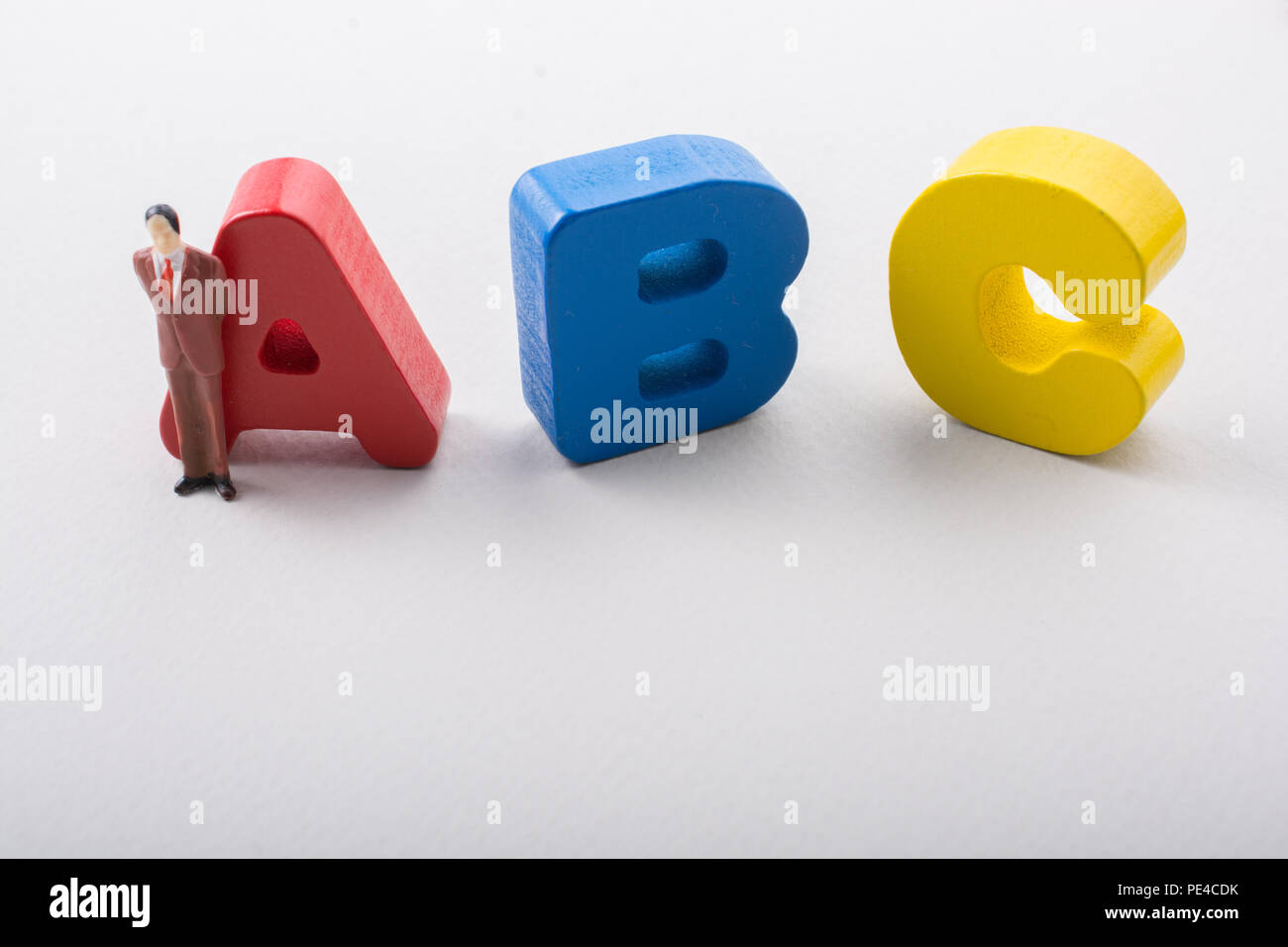 Man figurine and Letters of abc of alphabet on white Stock Photo - Alamy