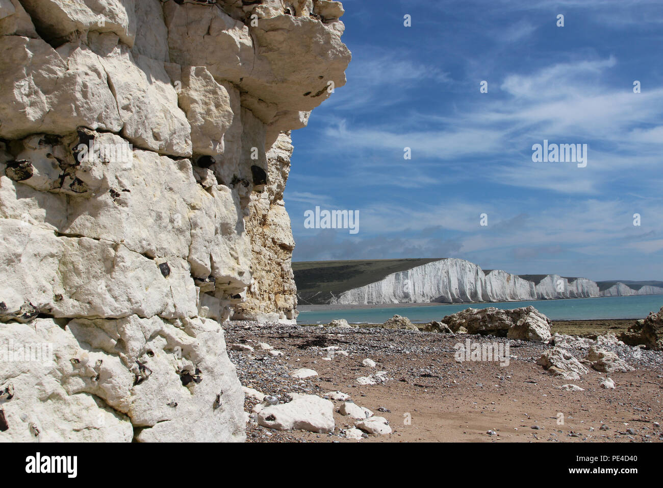 Overhanging chalk cliffs and Seven Sisters, beach, Hope Gap, Sussex ...