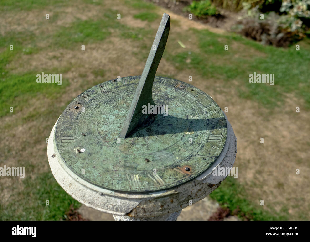 Antique sun dial in an English garden on summers day Stock Photo - Alamy