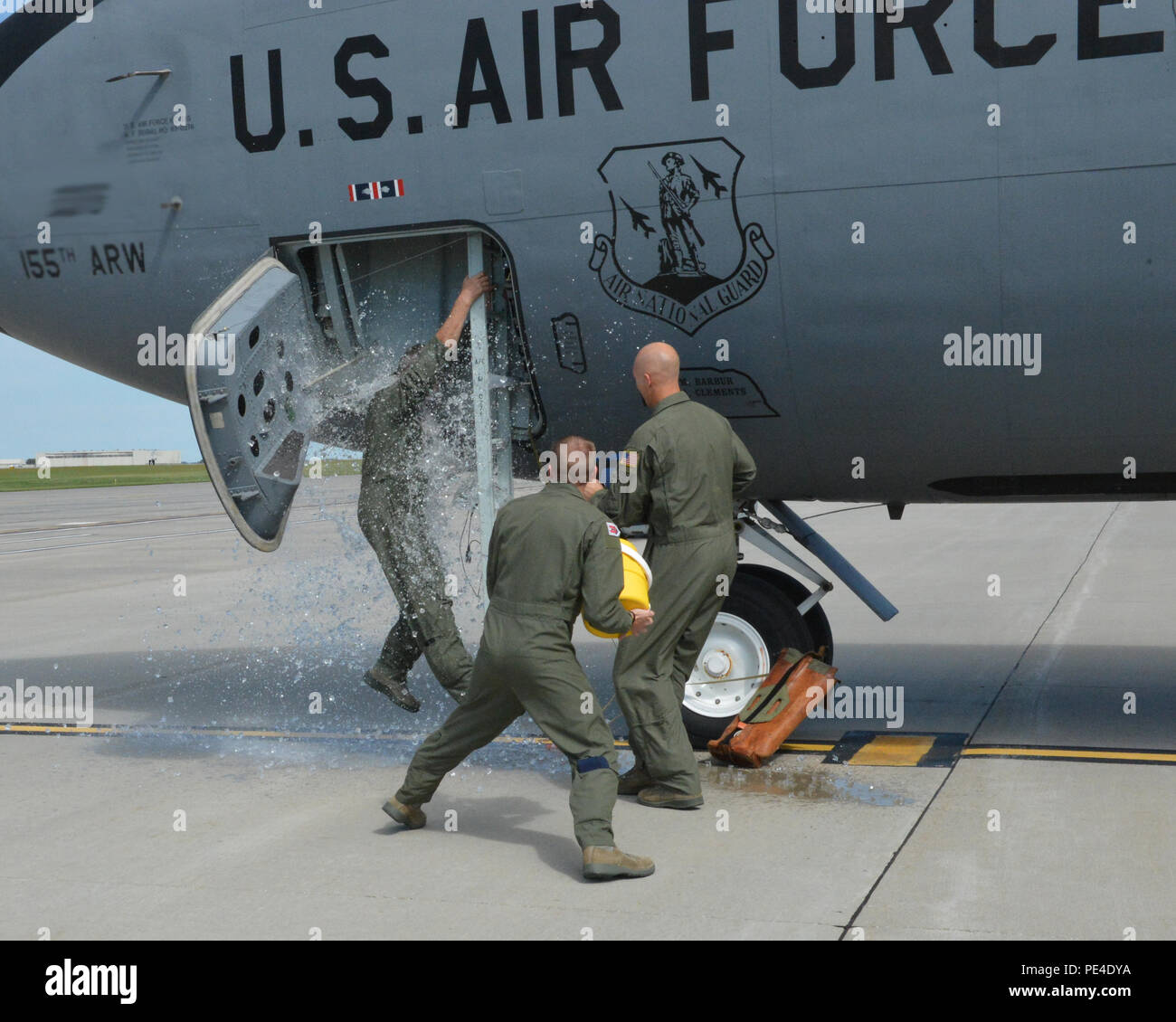 Members of the 155th Operations Group splash Master Sgt. Mike Minnick ...