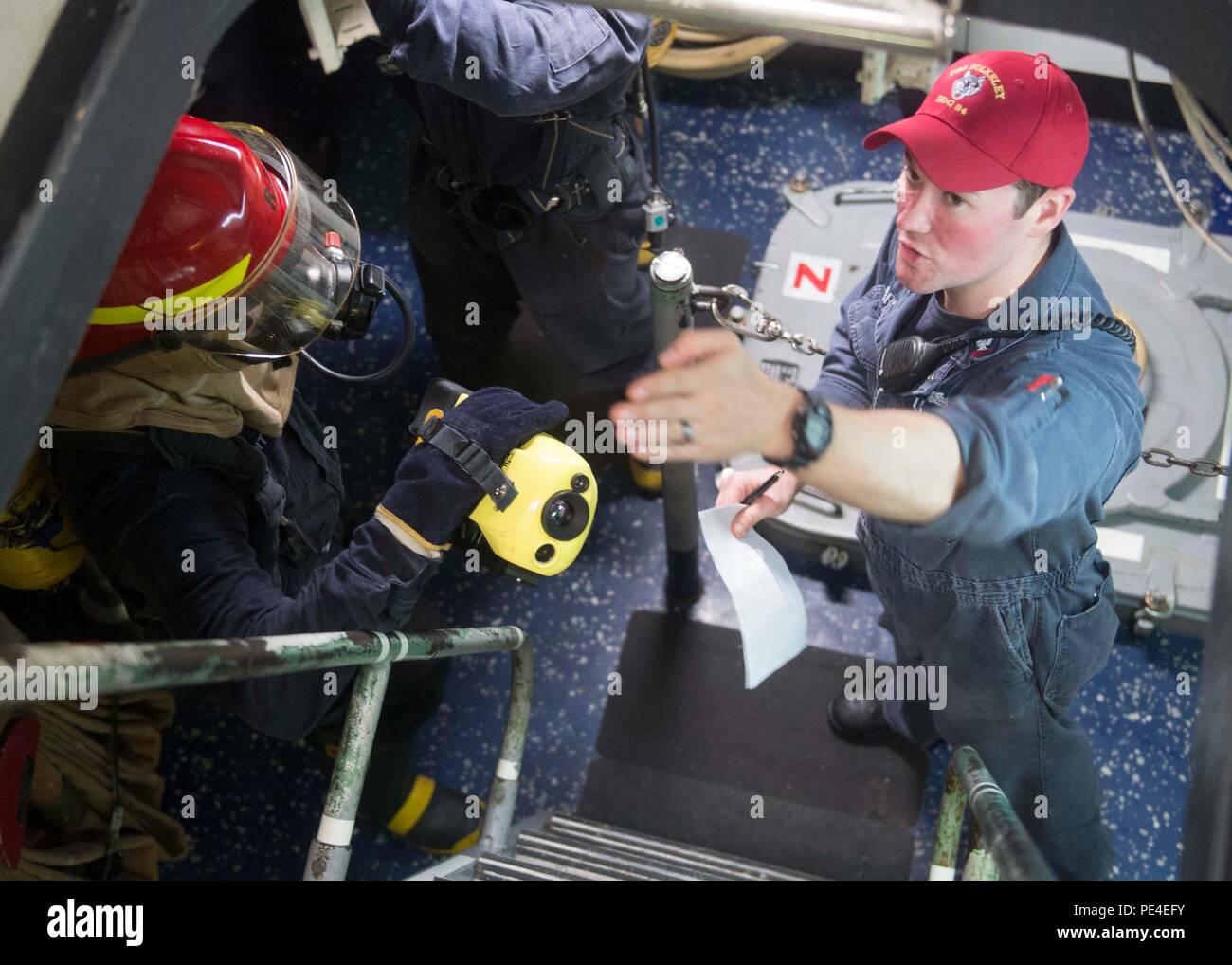 A Damage Controlman 1st Class aboard USS Bulkeley (DDG 84) provides ...