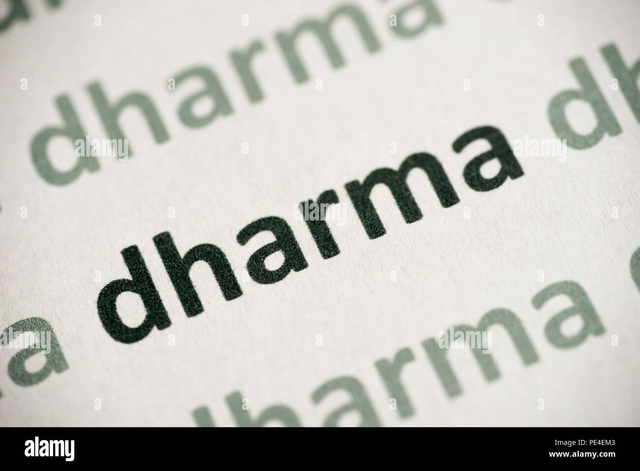 word dharma printed on white paper macro Stock Photo - Alamy