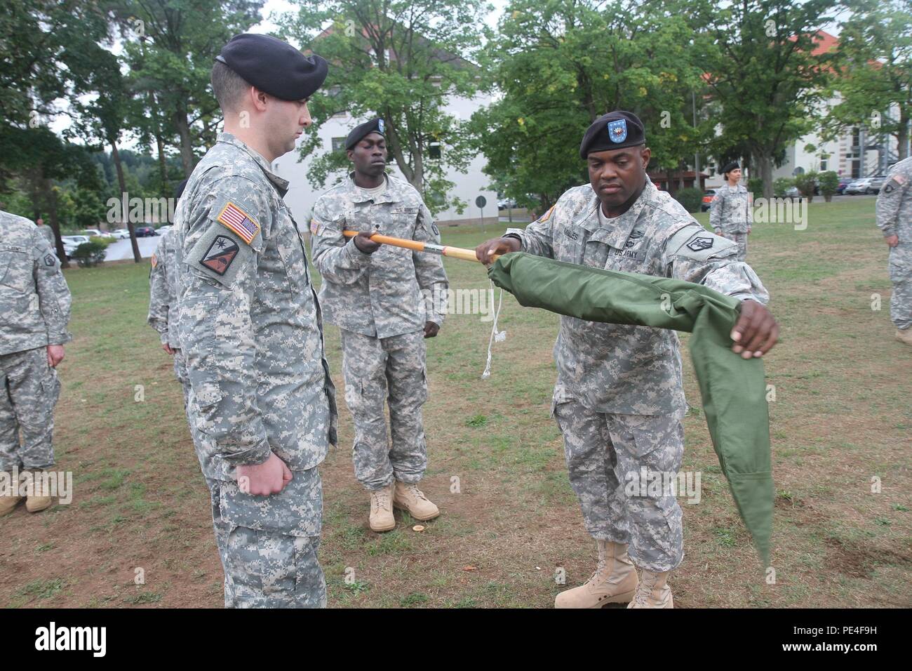 First Lt. Matthew Gaumer and Sgt. 1st Class Bertram Giles uncase the ...