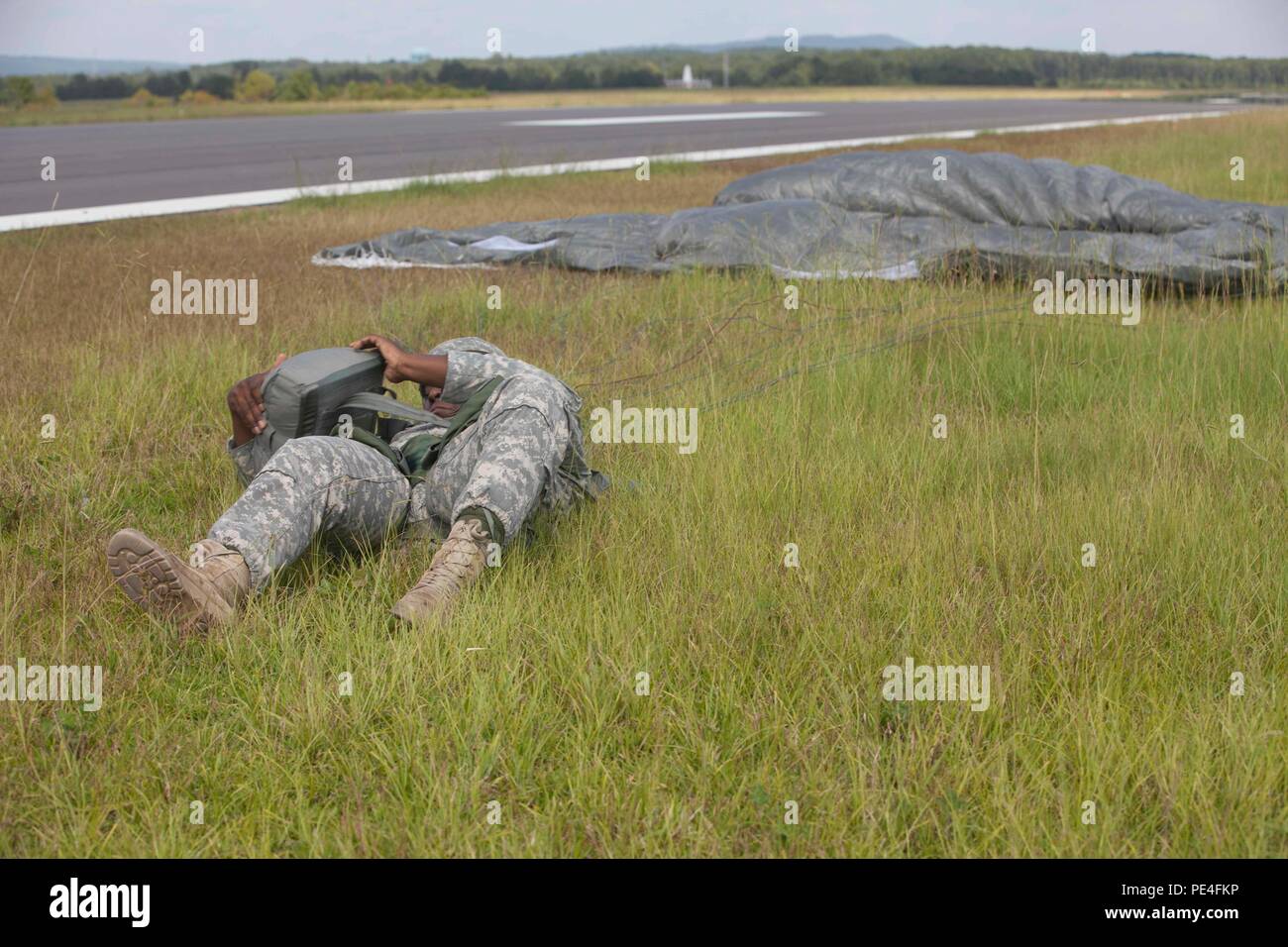 A U.S. Army paratrooper unhooks his reserve parachute on Steve Osborne ...
