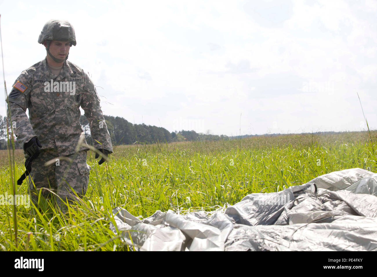 A U.S. Army paratrooper begins to gather his parachute on Steve Osborne ...