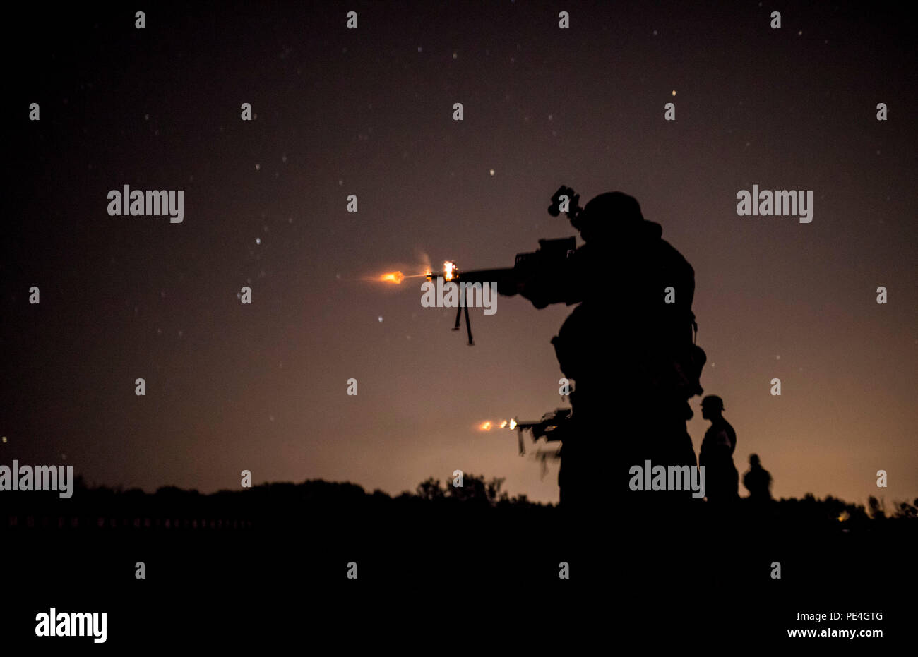 Canadian Army soldiers fire during a light machine gun night fire match ...