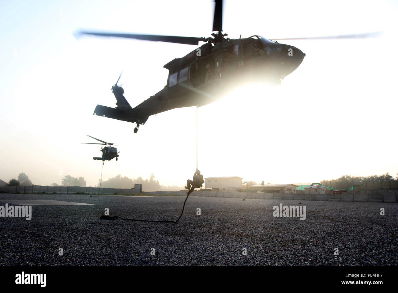 A 3rd BCT, 101st Airborne Division soldier descends from a UH-60 Black ...