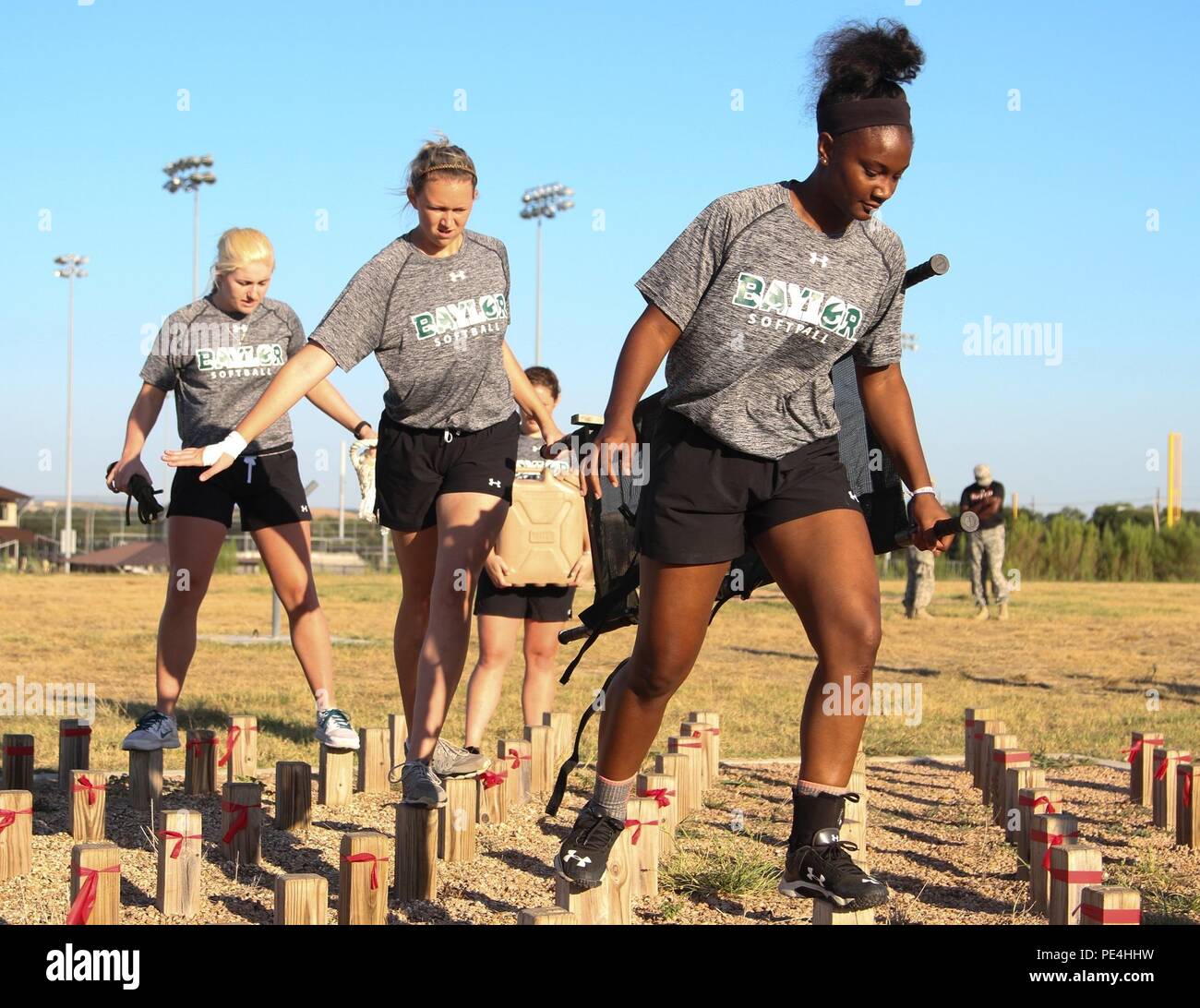 Members of the Baylor University softball team negotiate an obstacle ...