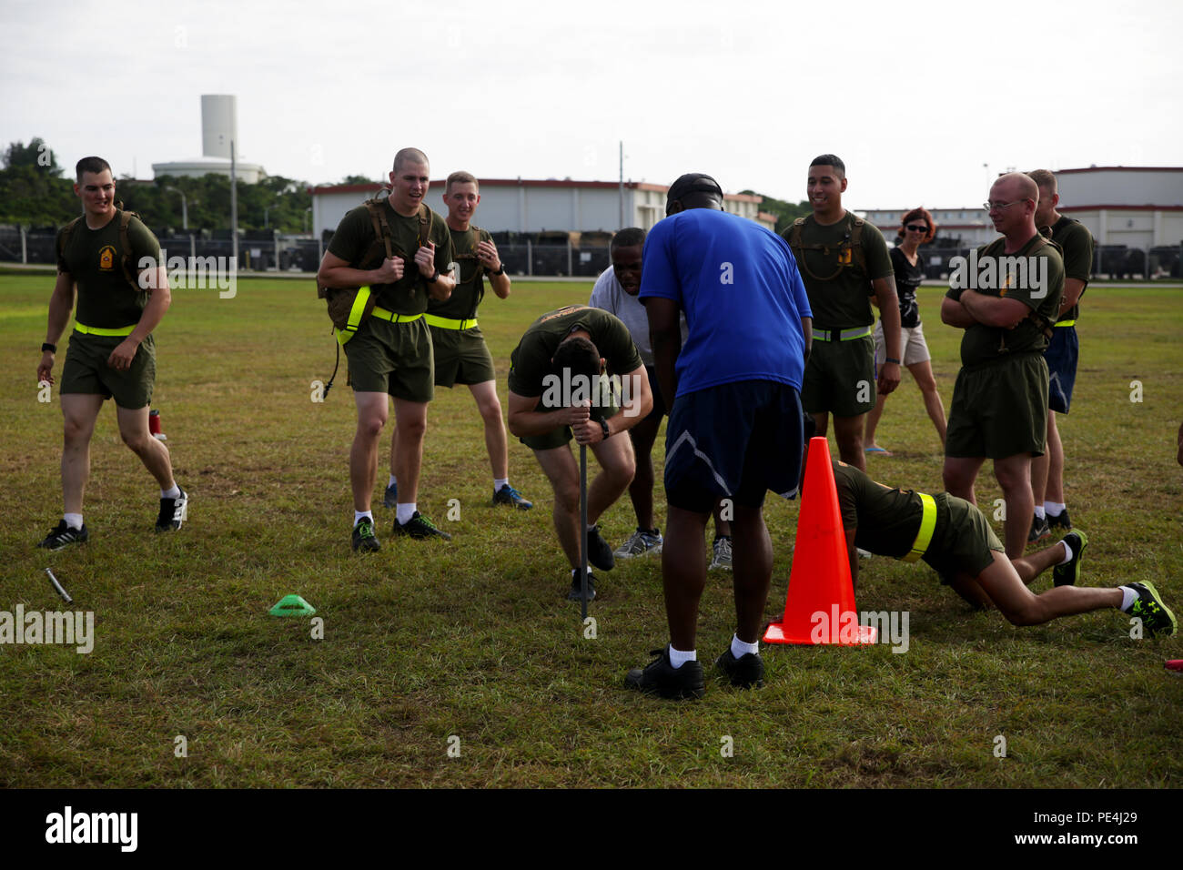 Marines and airmen participate in the “dizzy izzy” portion of a relay ...