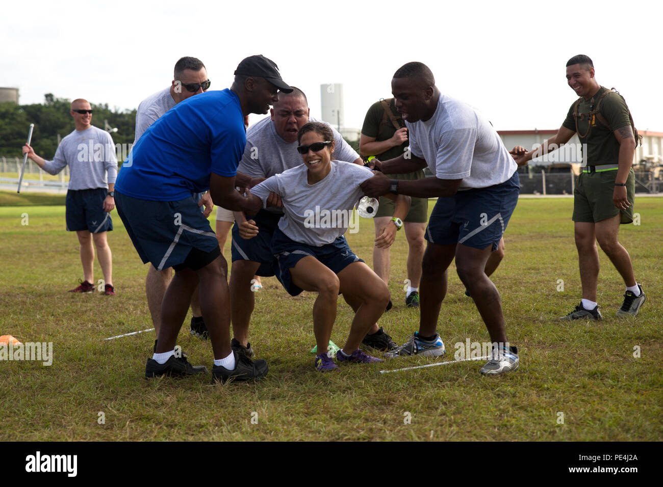 Marines and airmen participate in the “dizzy izzy” portion of a relay ...